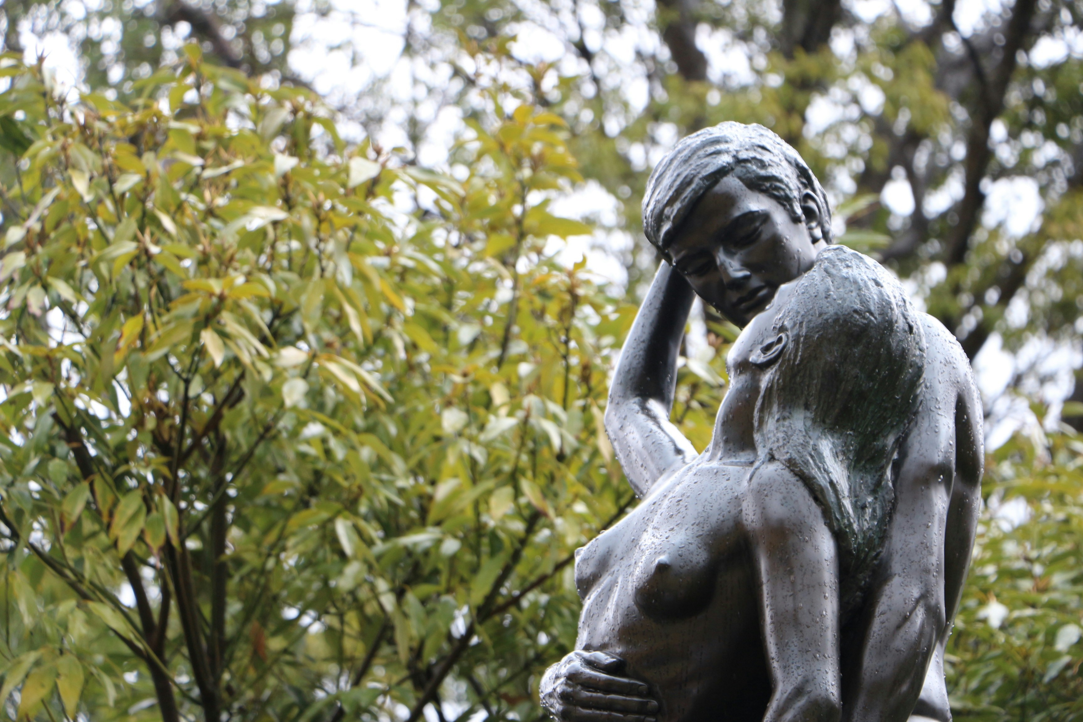 Prison of Quiet Contemplation: A Bronze Figure Amid autumn Leaves