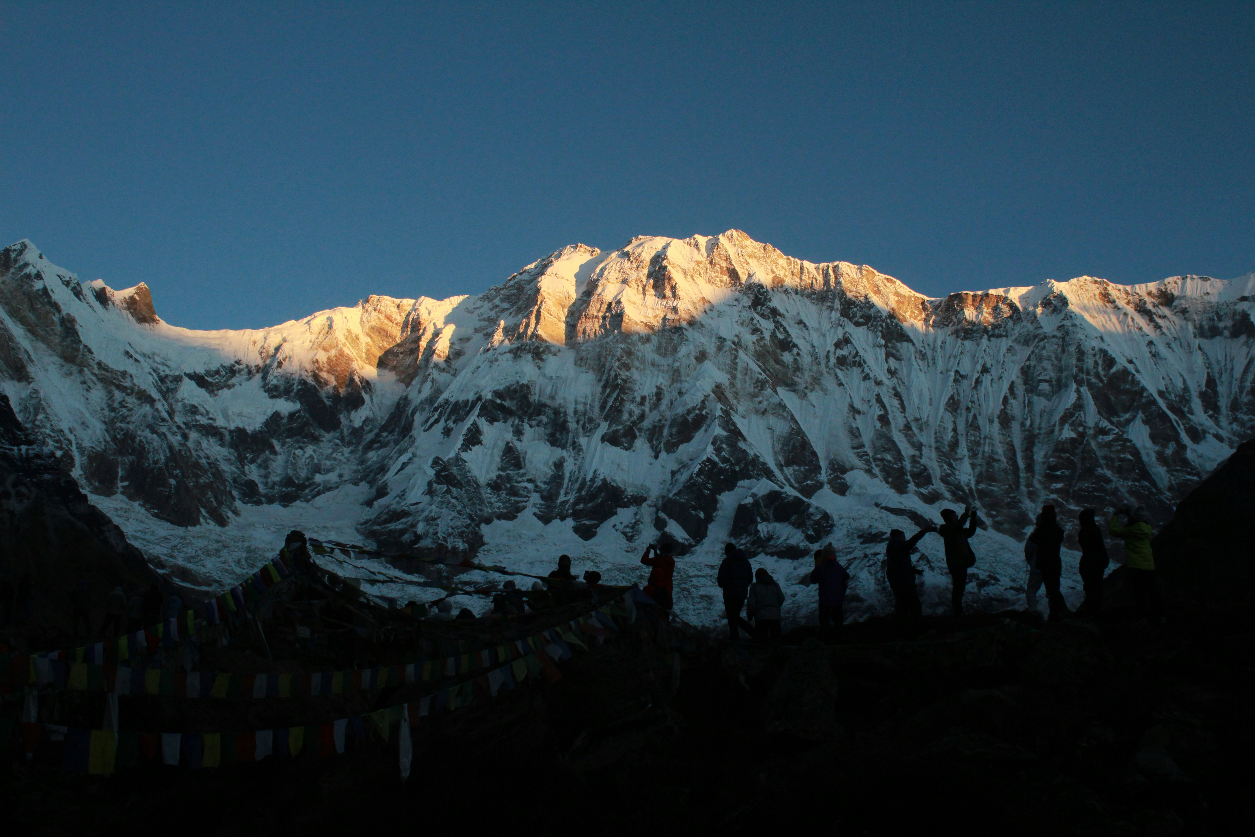 Golden Crest: Peaks at Dusk with Shadowed Camp Silhouettes