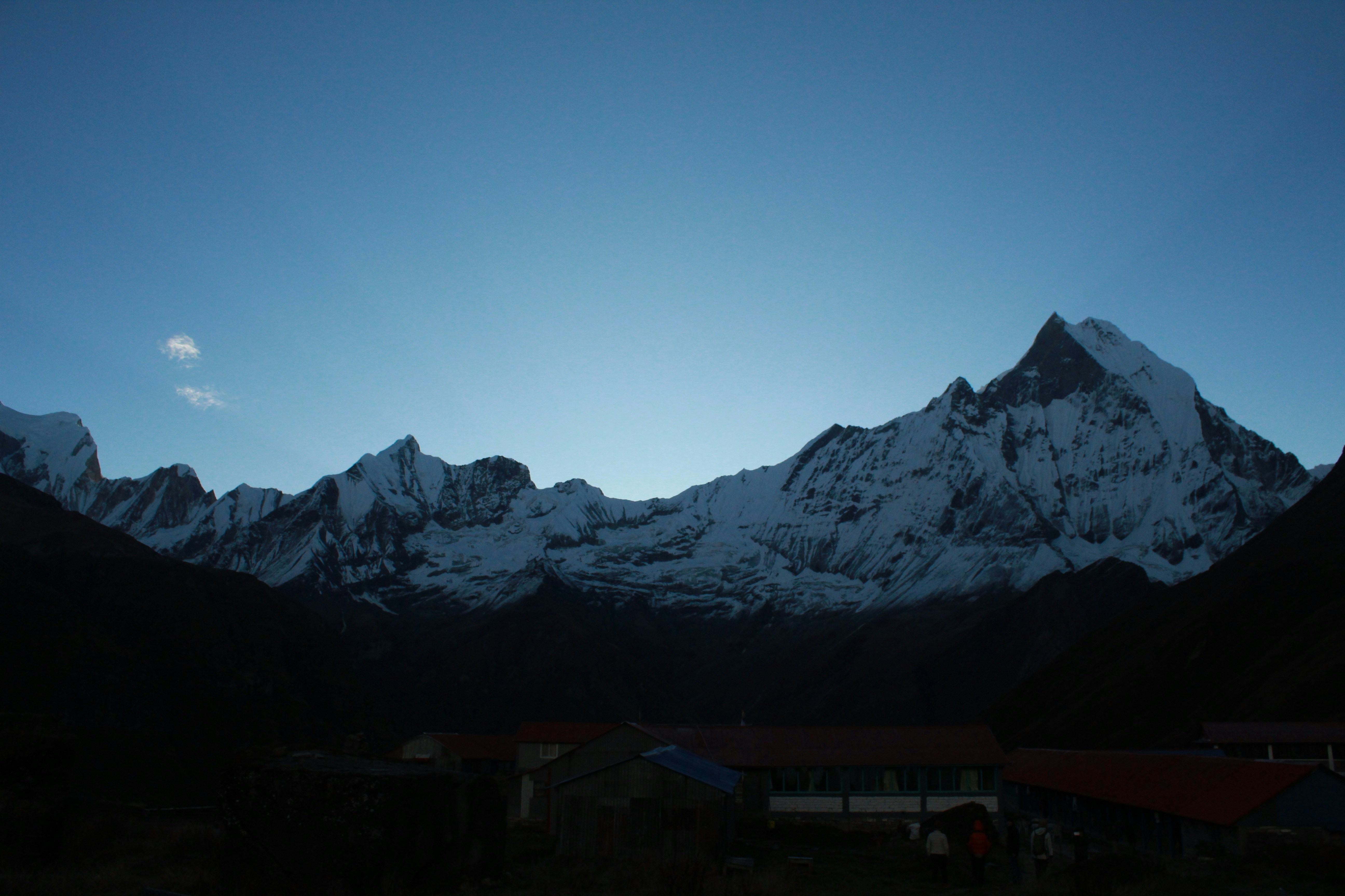 Snow-kissed Peaks at Dusk Over a Quiet Alpine Village