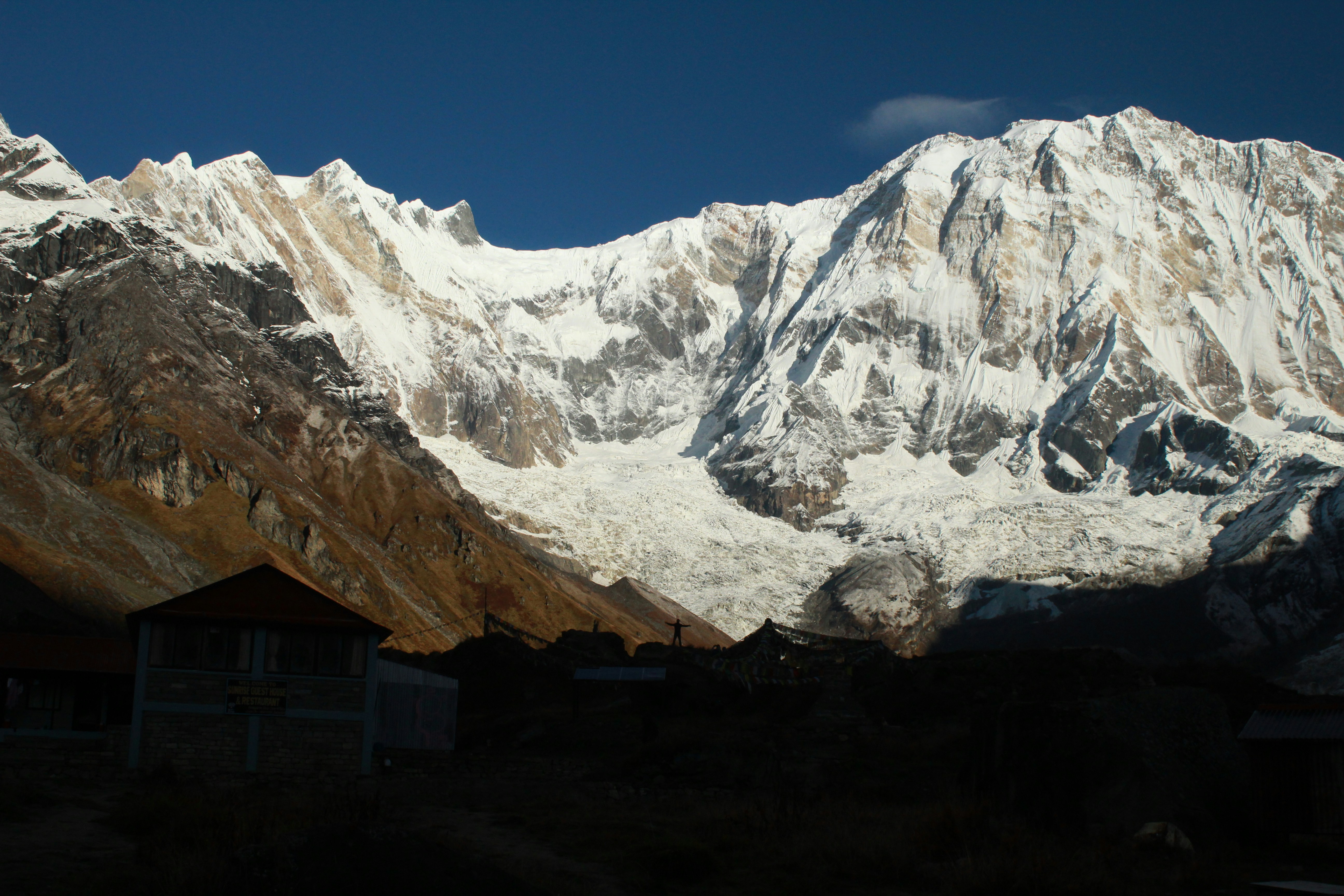Snowbound Giants: Peaks Arising Over a Dark Alpine Village
