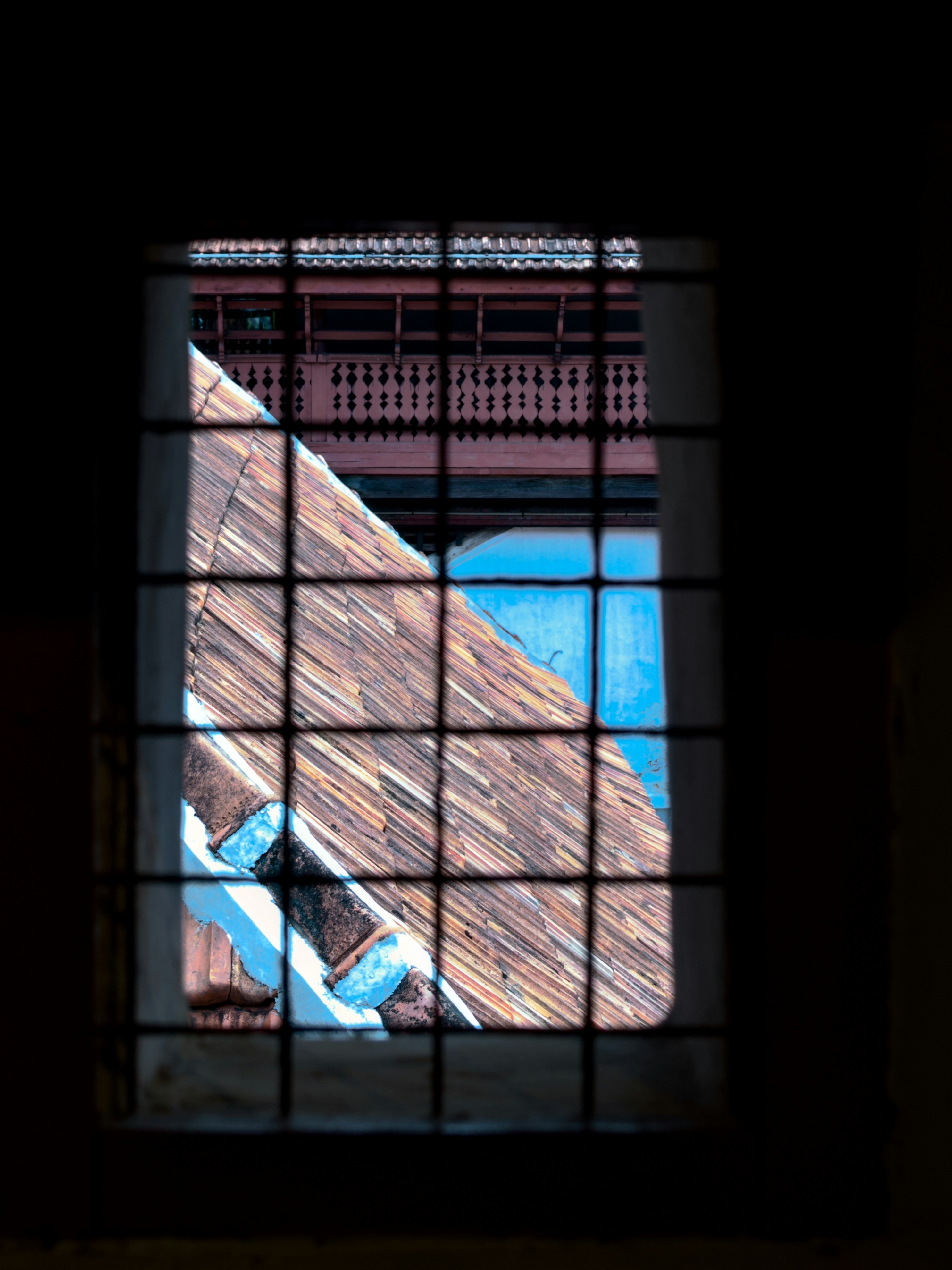 Rusted Roof Through a Gridded Window