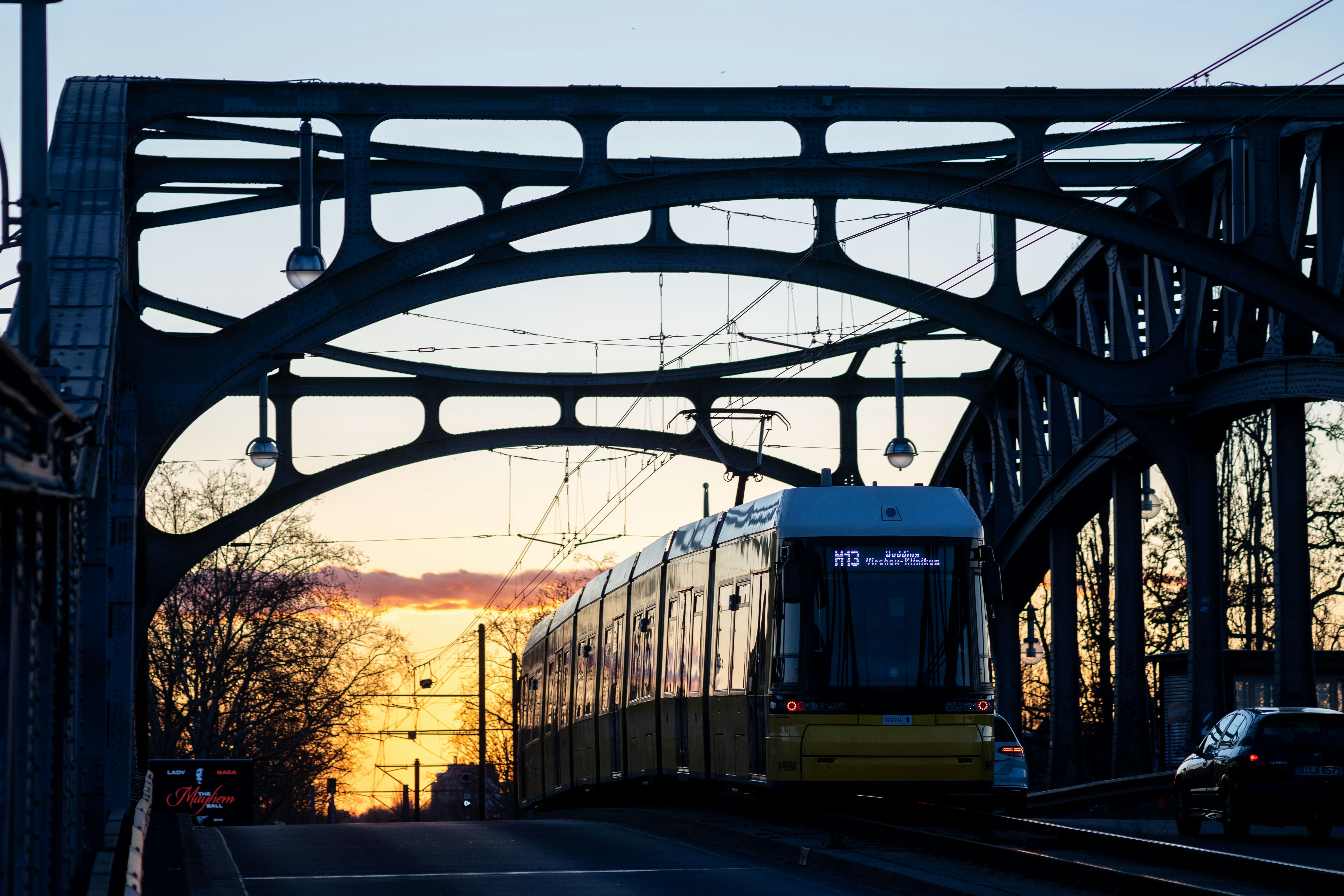 Sunset Over the Steel Arches as a Tram Glides Across