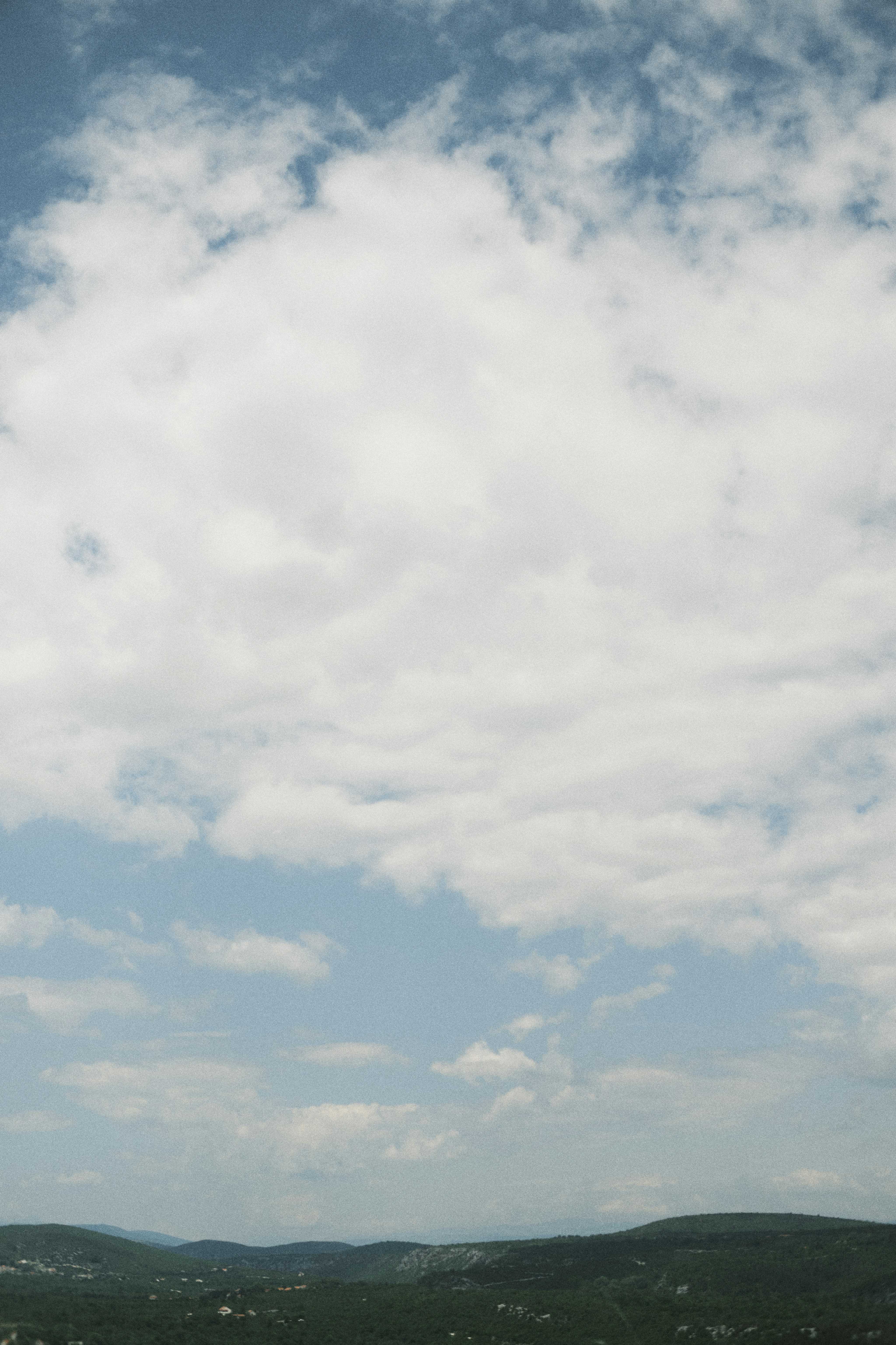 Above the Valley: A Quiet Sky Over Rolling Hills
