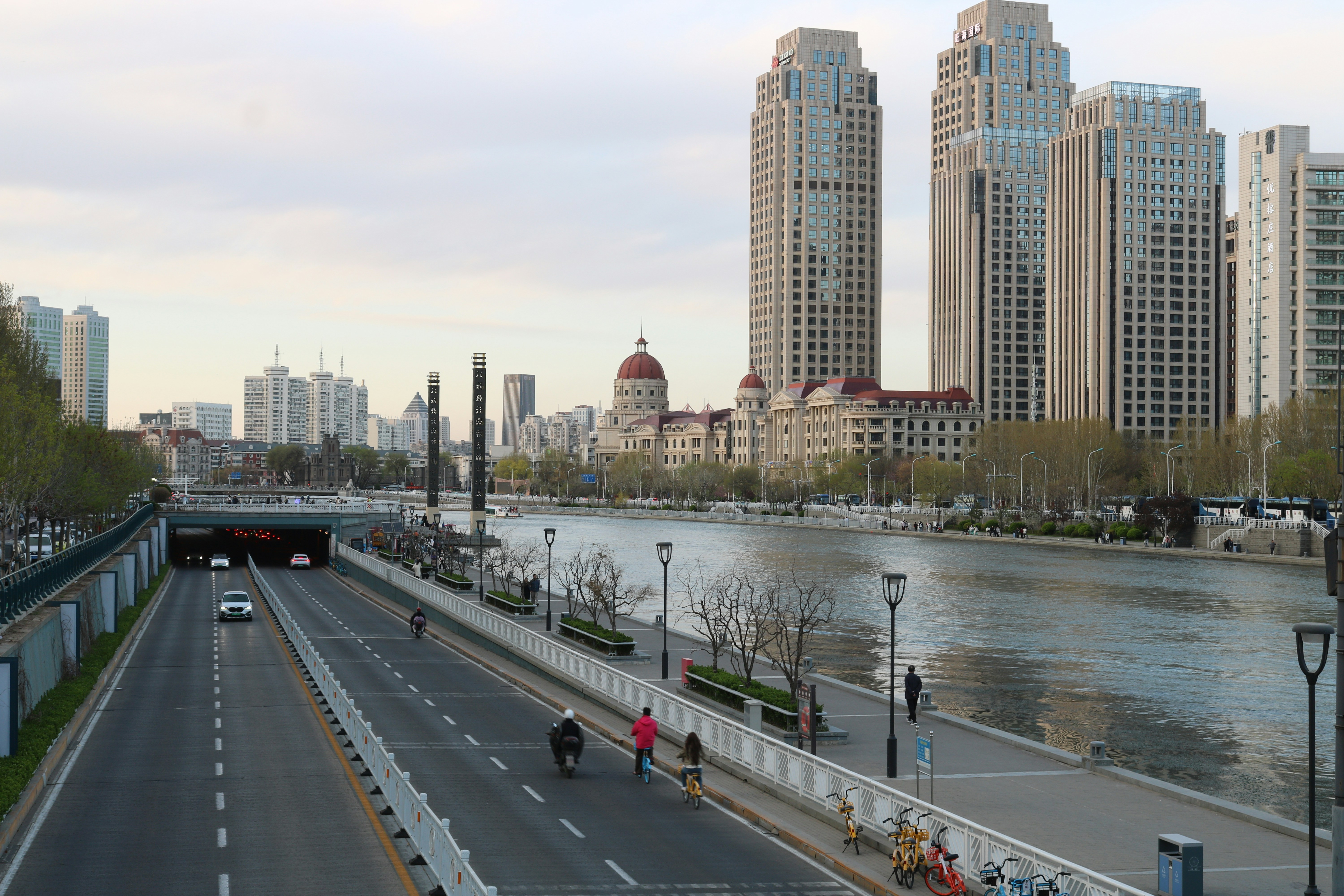 Riverfront Cityscape with High-Rise Skyline and Promenade