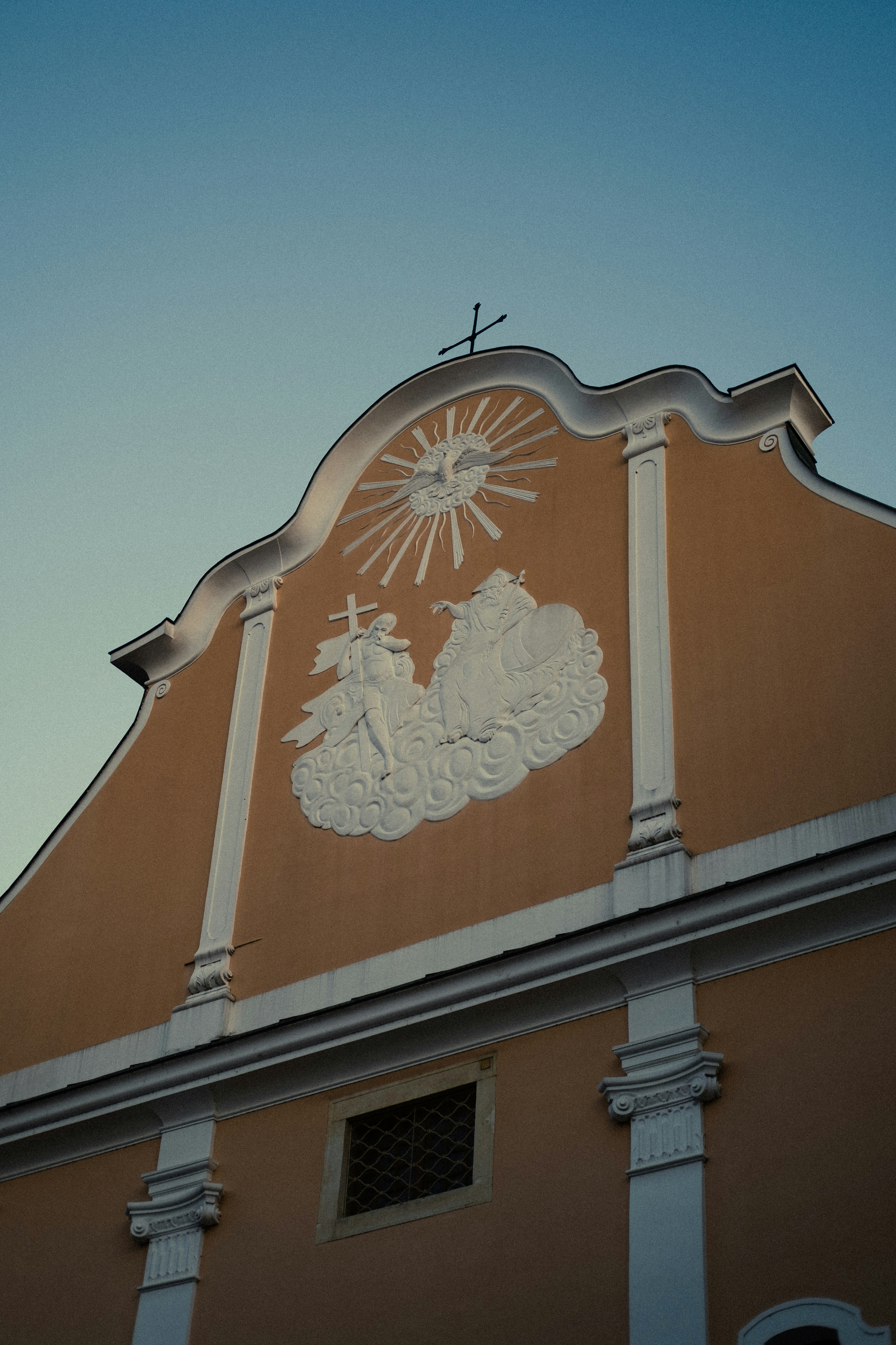 Church Frieze at Dusk: A Stately Crest Against a Clear Sky