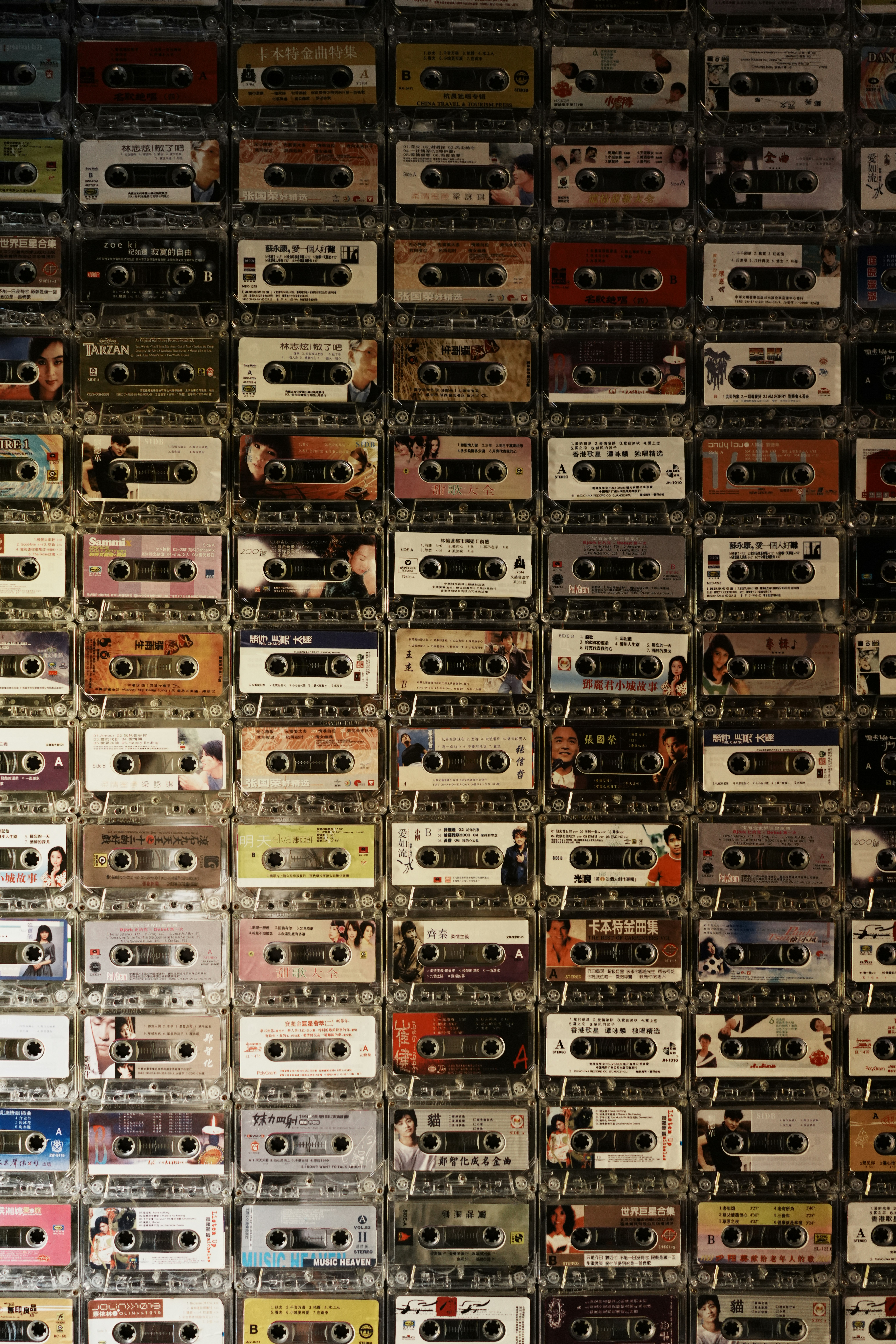 A wall of nostalgia: hundreds of cassette tapes stacked in a grid