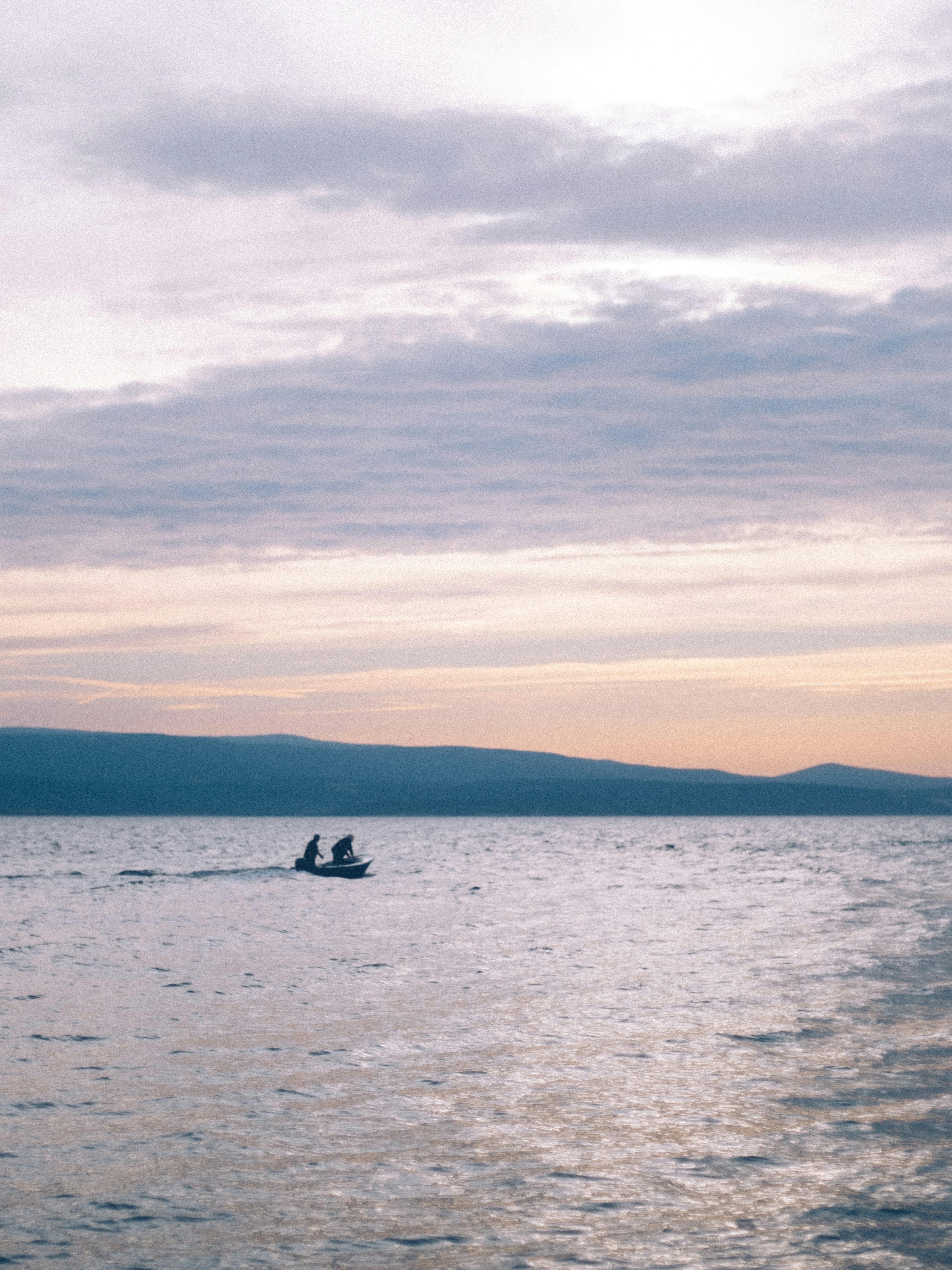 Distant Rowboats at Twilight over Silky Seascape
