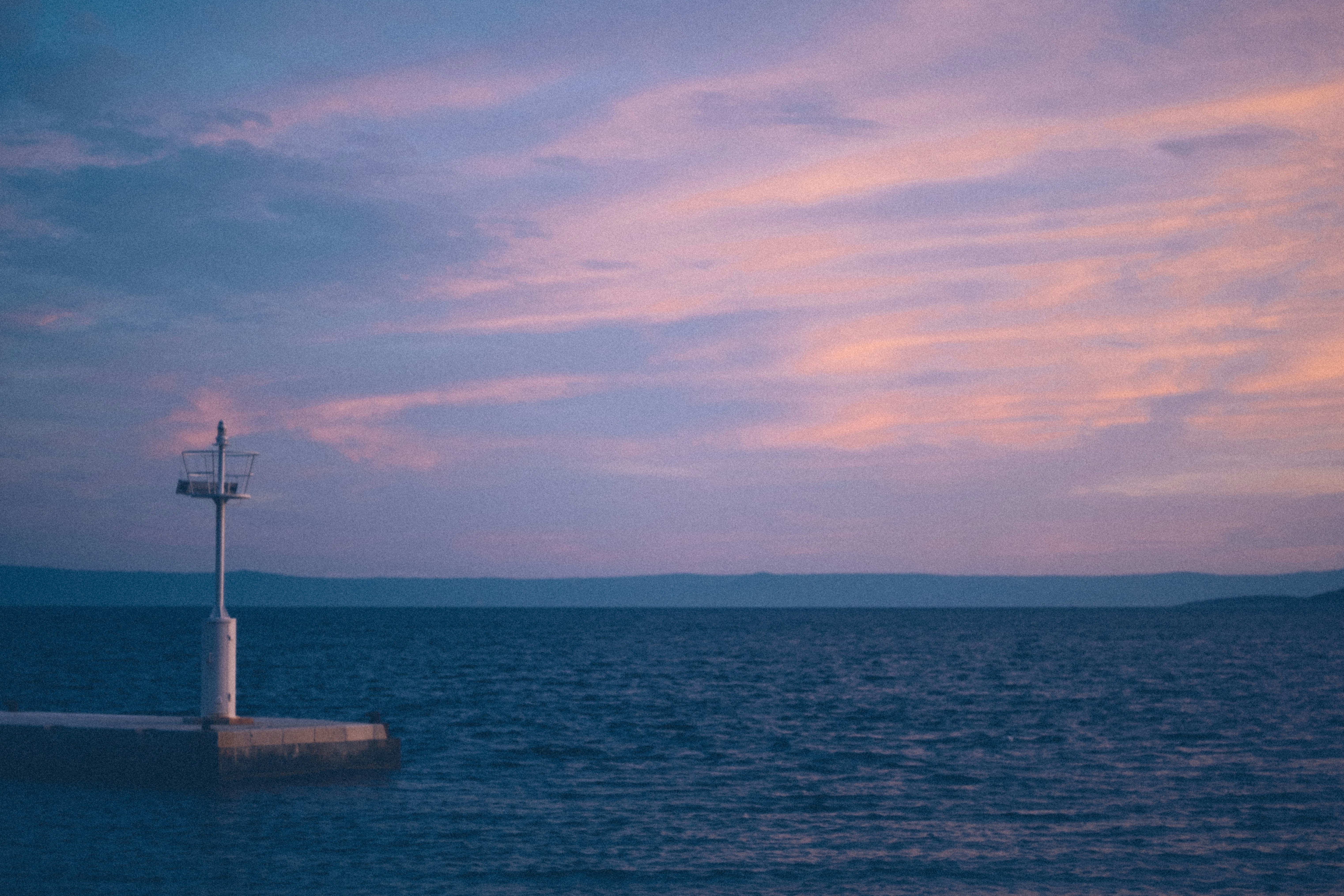 Dusk at the Pier: Pink-Blue Horizon Over Quiet Sea