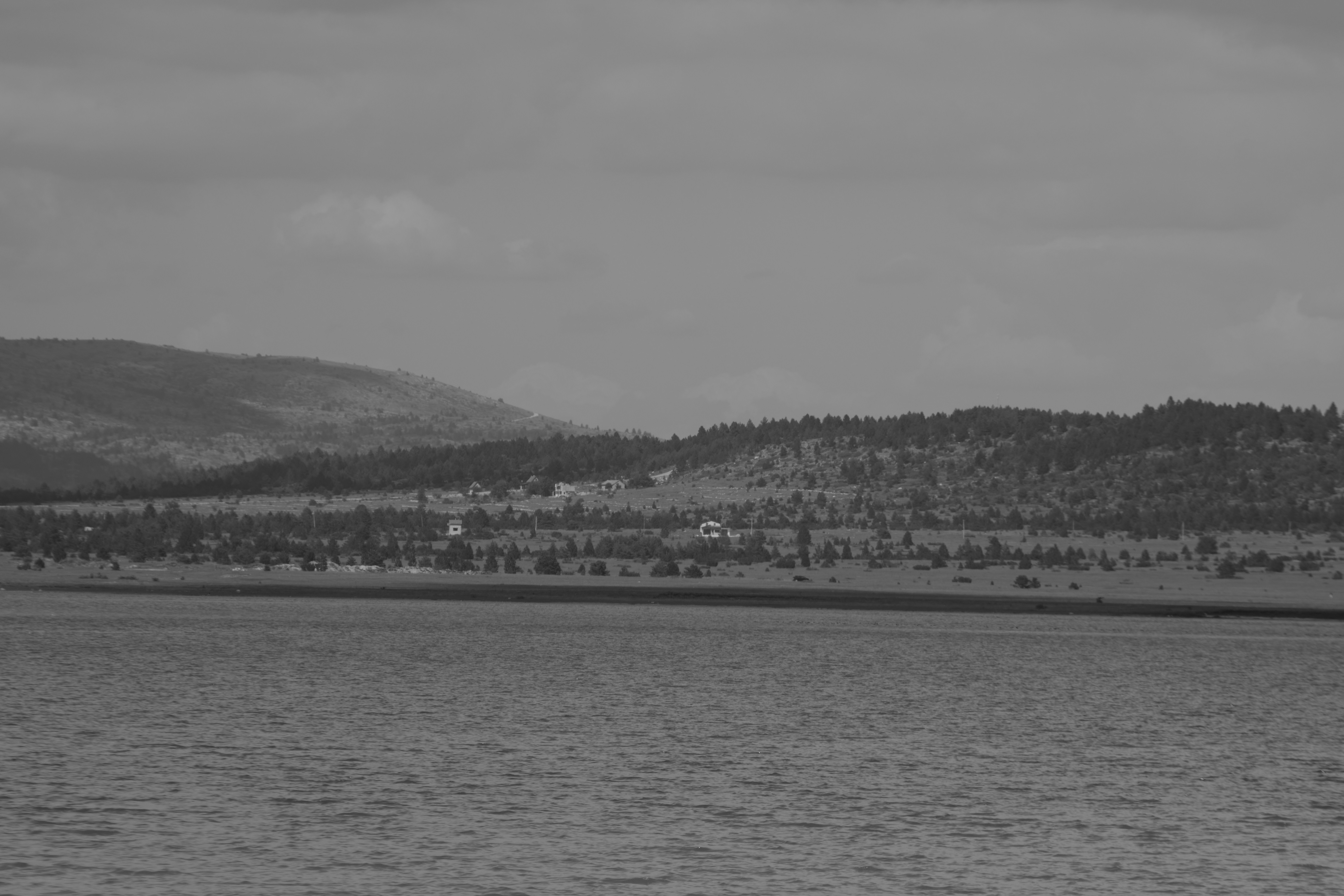 Quiet Lakeside Band: A Ridge and Water Horizon in Monochrome