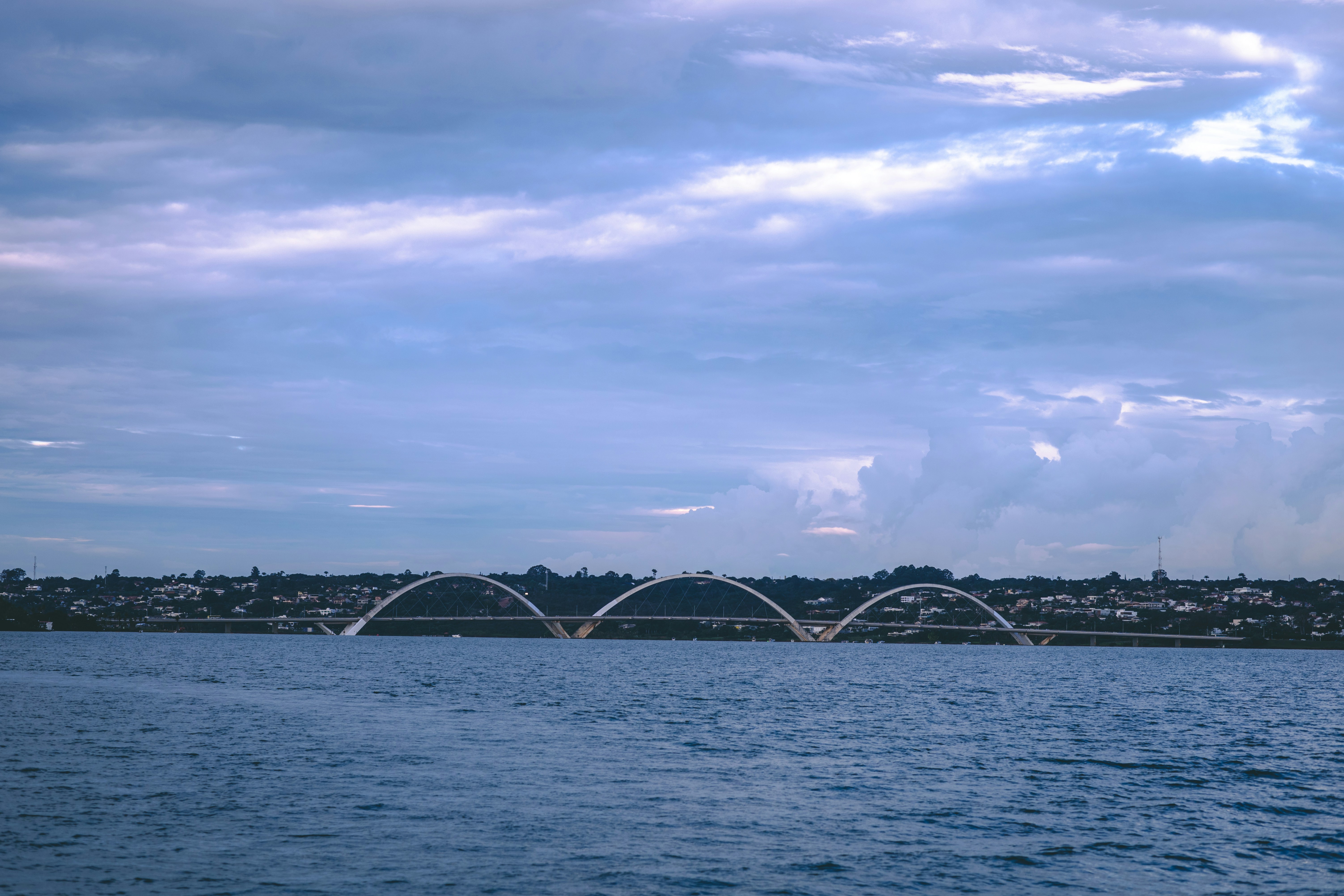 Arched Bridge Silhouette Across Calm Waters at Dusk