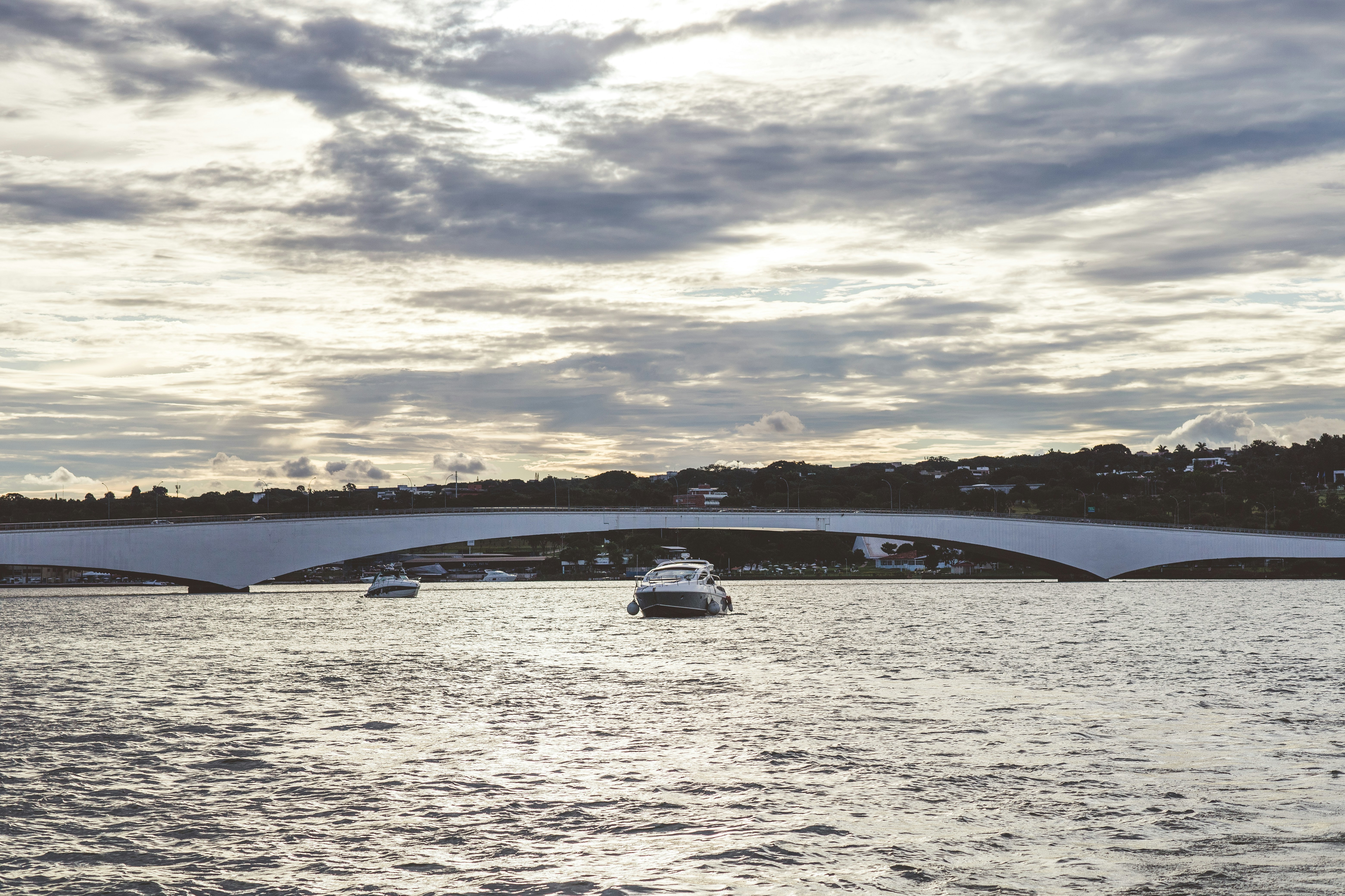Bridge at Distant Horizon: Boats, Water, and a Silent Sky