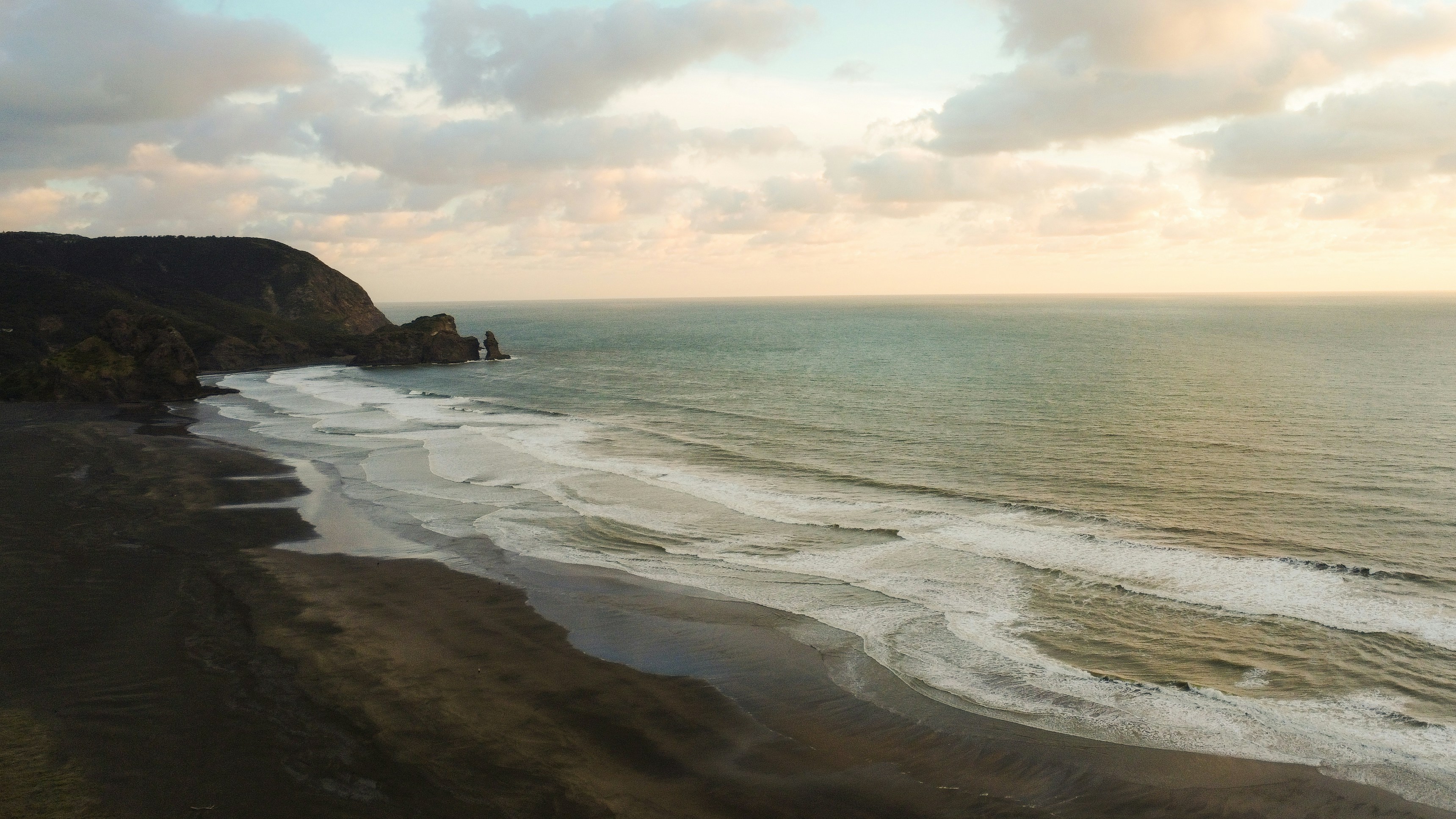 Cliffside Coastline at Dusk: Gentle Waves Meet Quiet Horizon