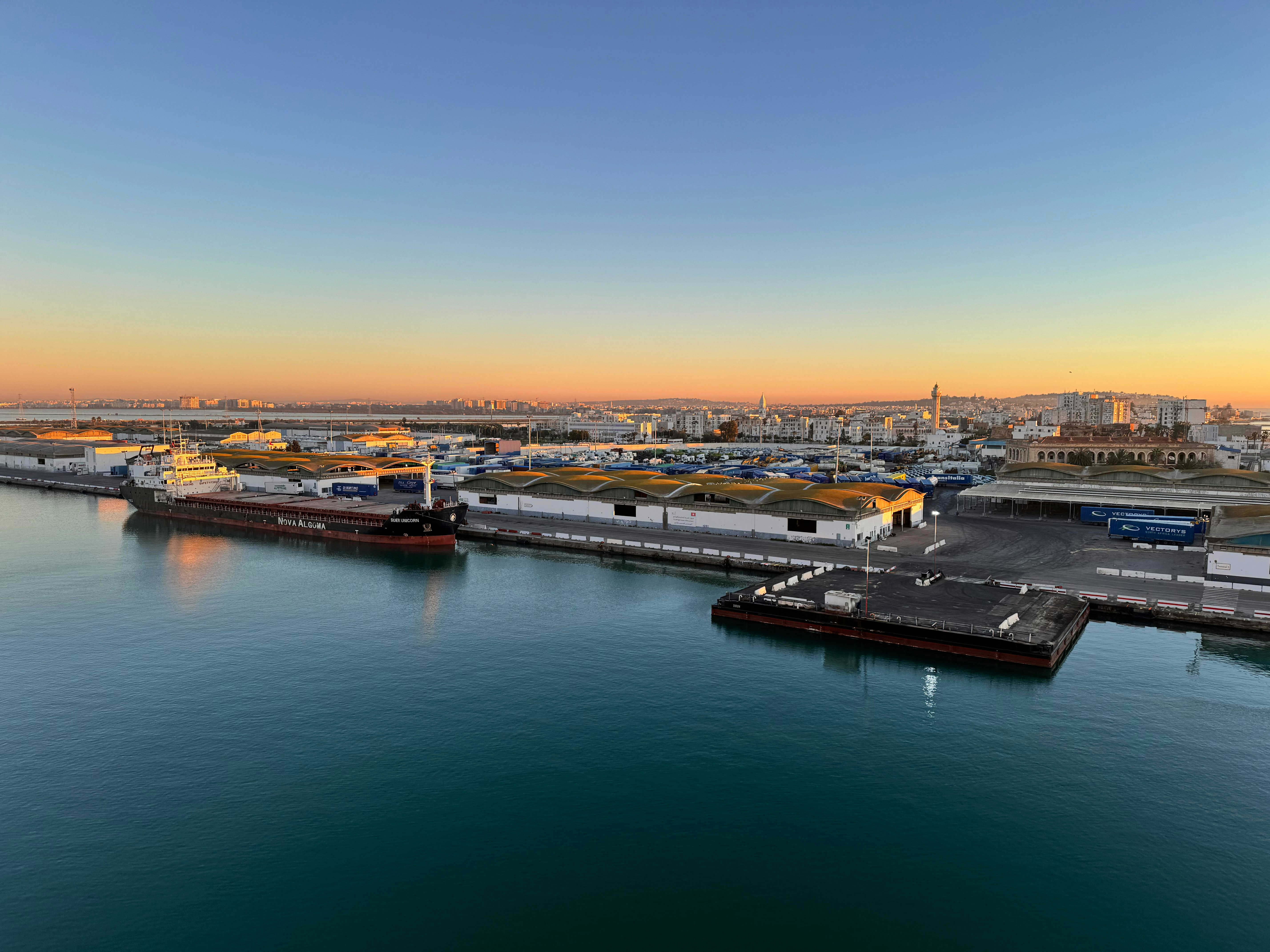 Golden Hour at the Marina: Boats, Docks, and Distant City Lights