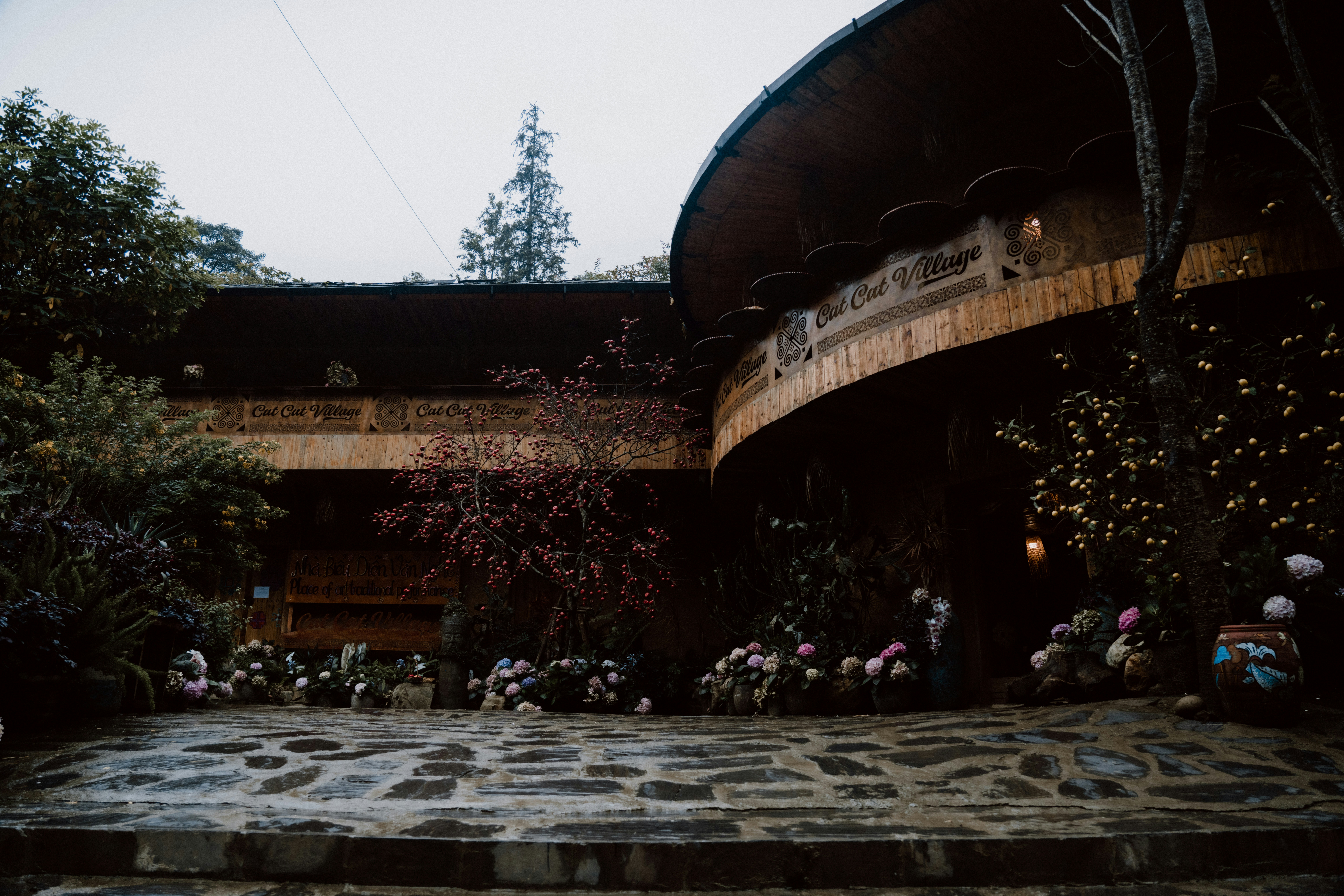 Quaint Villa Archway bathed in dusk with flowering border