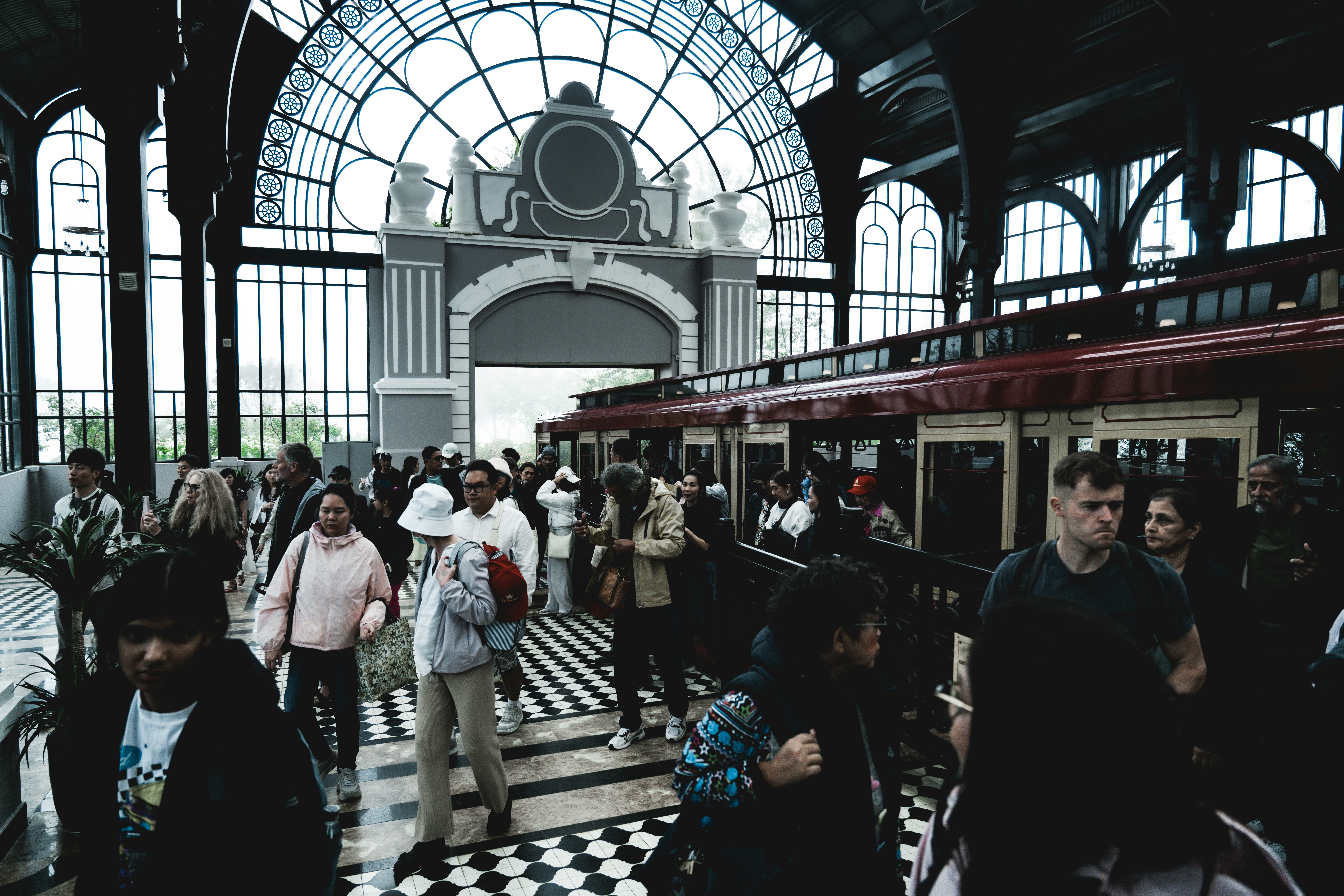 Clocked in at the Grand Hall: People Await the Train beneath a Monolithic Arch