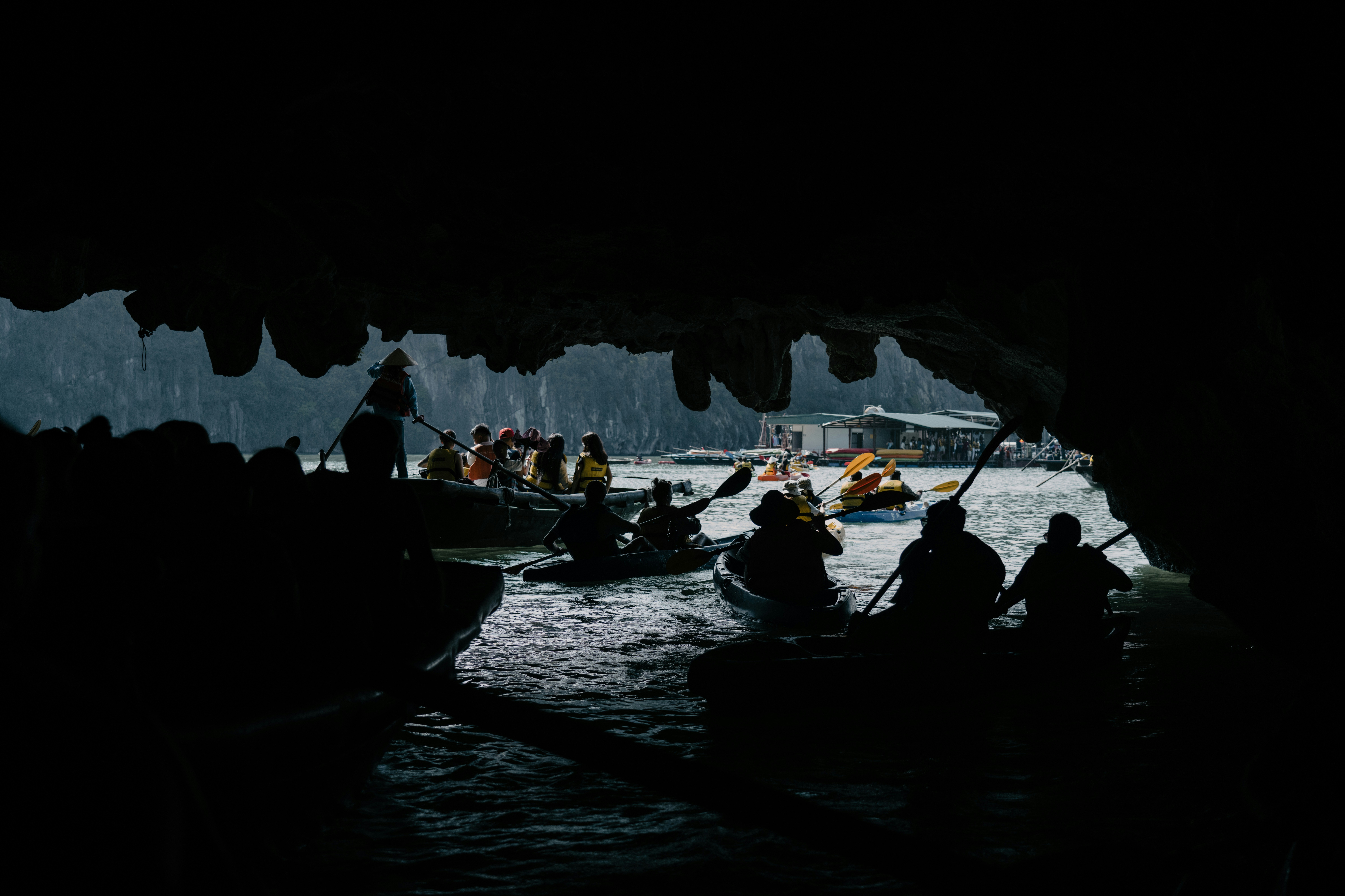 Emergence of Kayaks from a Moonlit Sea Cave