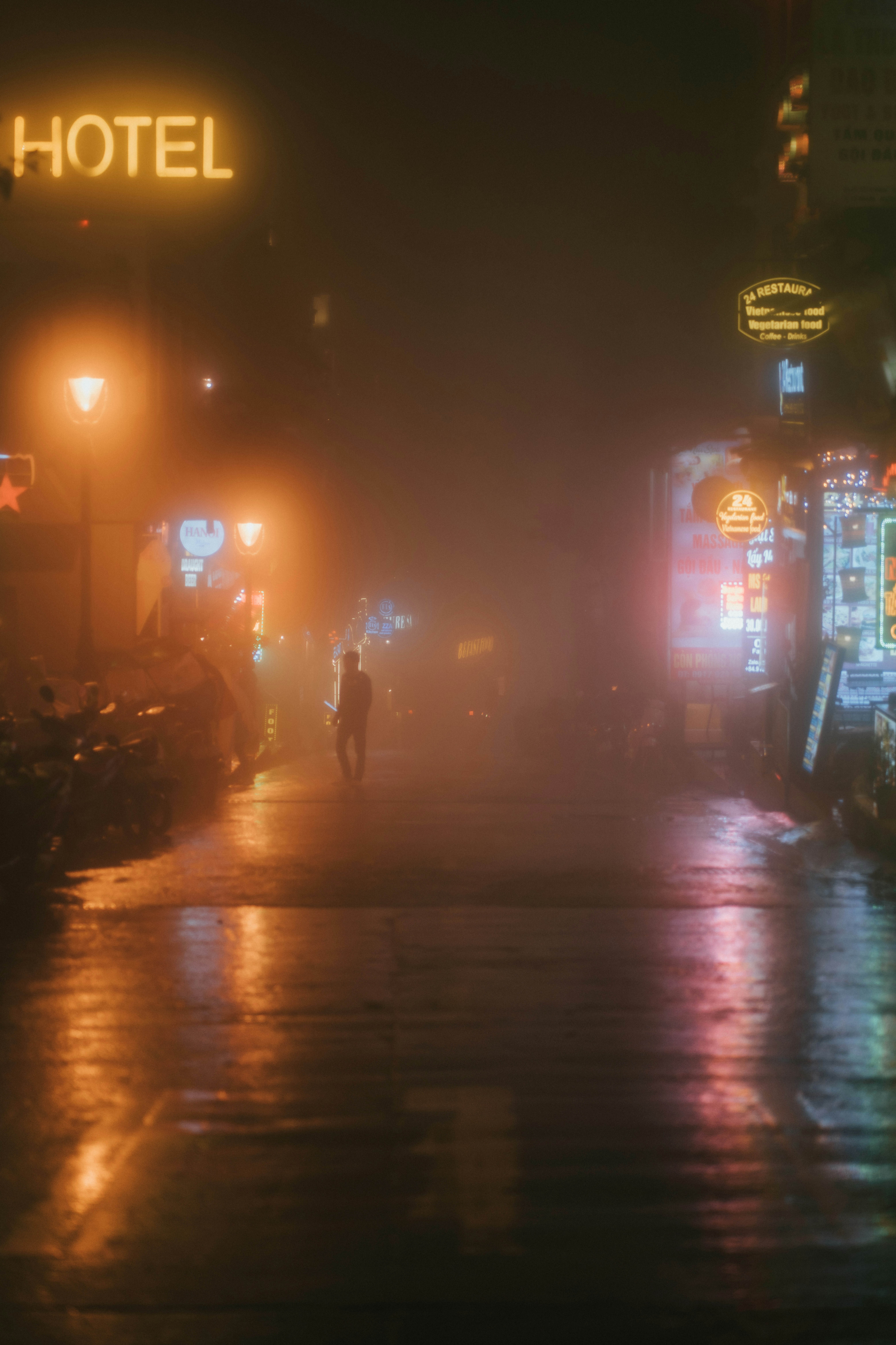 NeonMist Street: A solitary Figure in a Rainy Night
