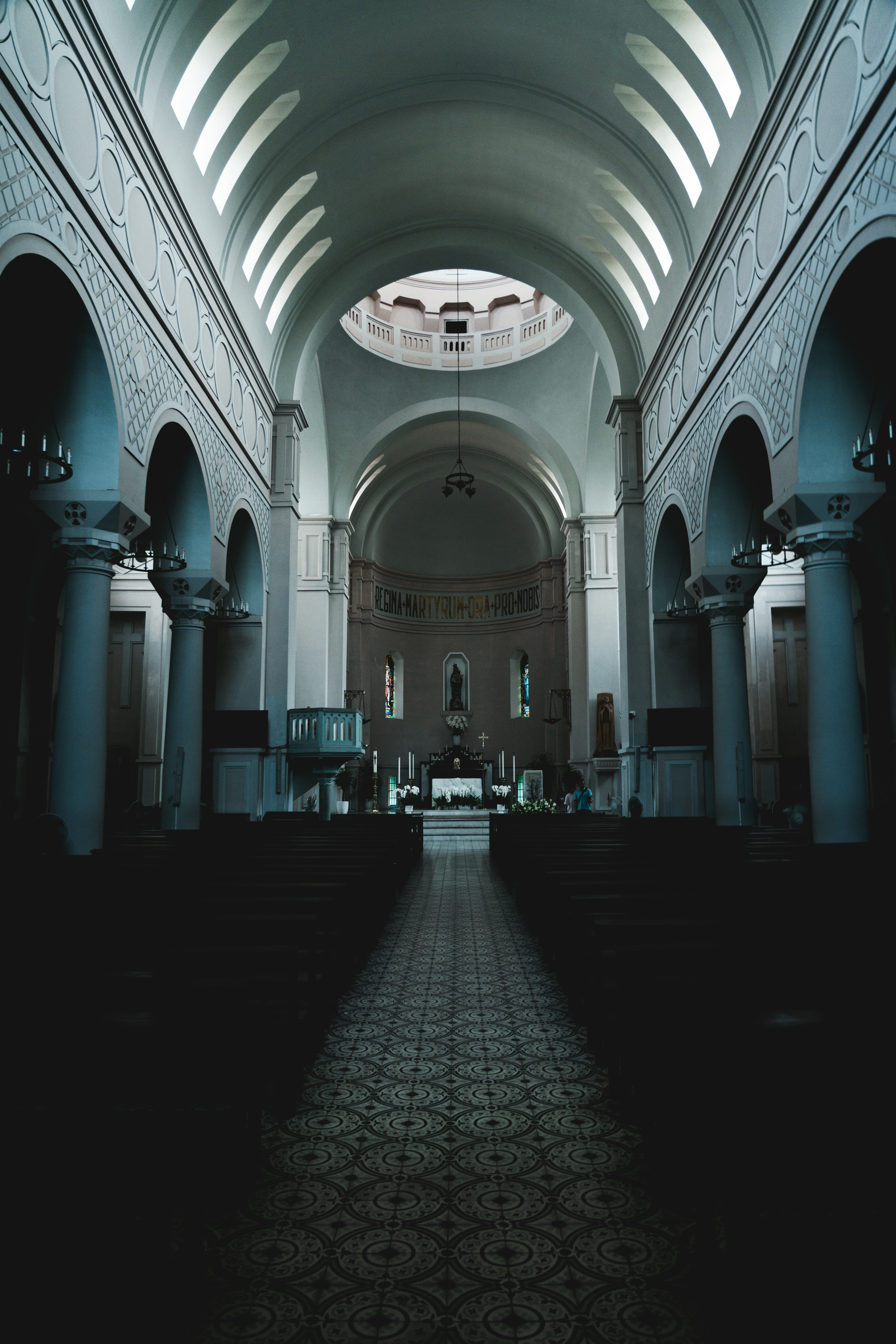 Cathedral-like nave: symmetry and light guiding the eye to the distant altar