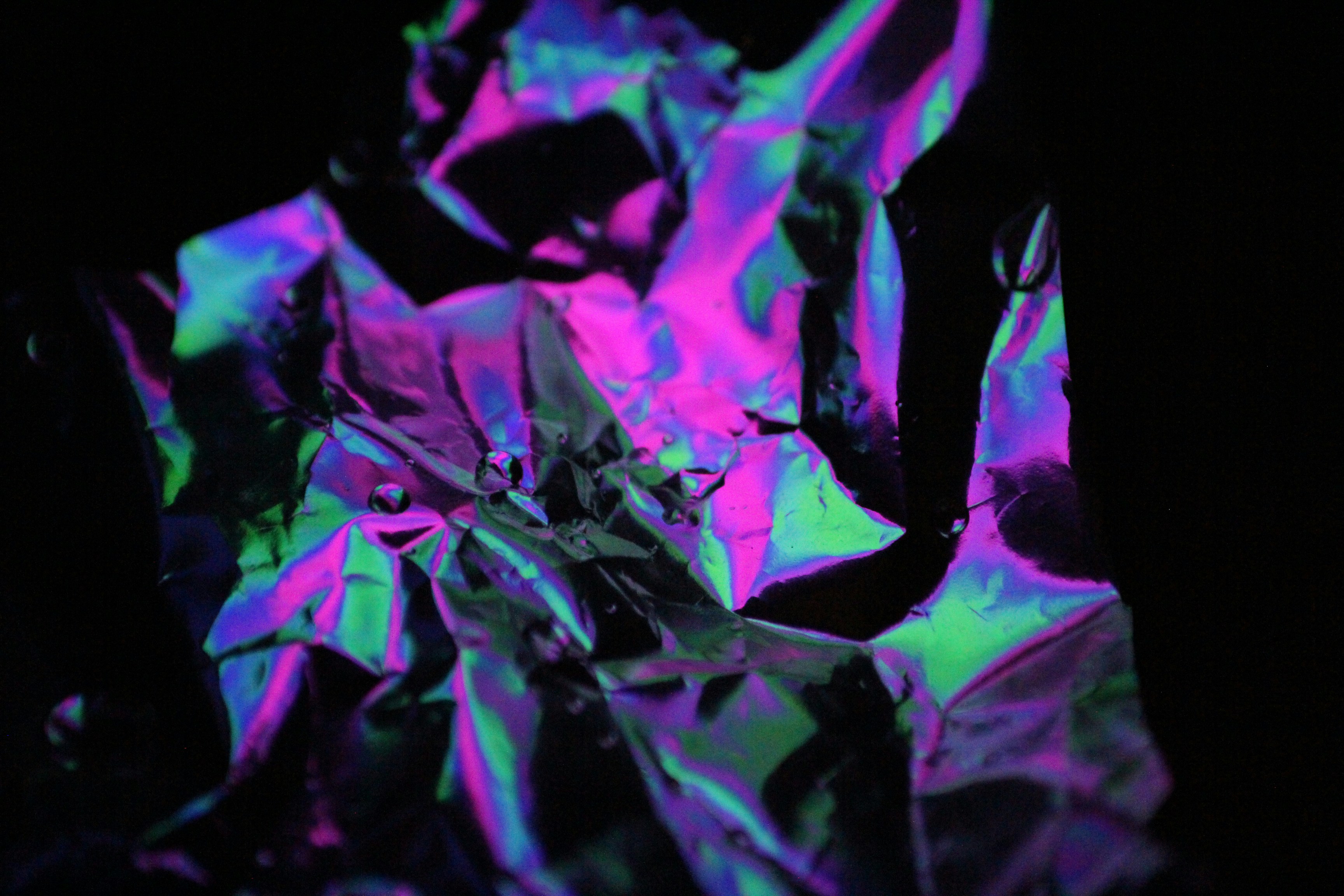Neon Crumple: Iridescent Paper in a Void