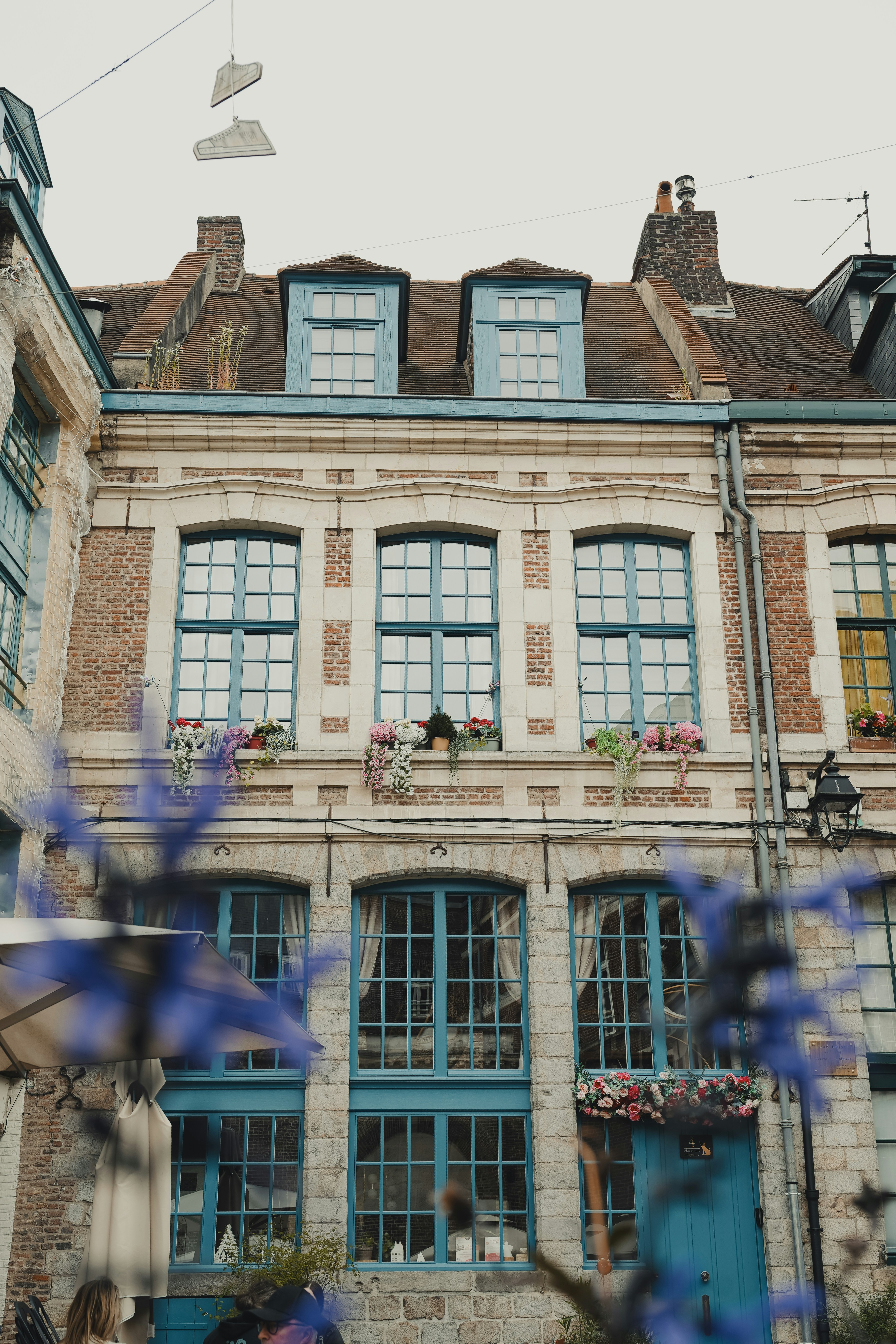 Charmed Facade: A European Balcony of Blooms