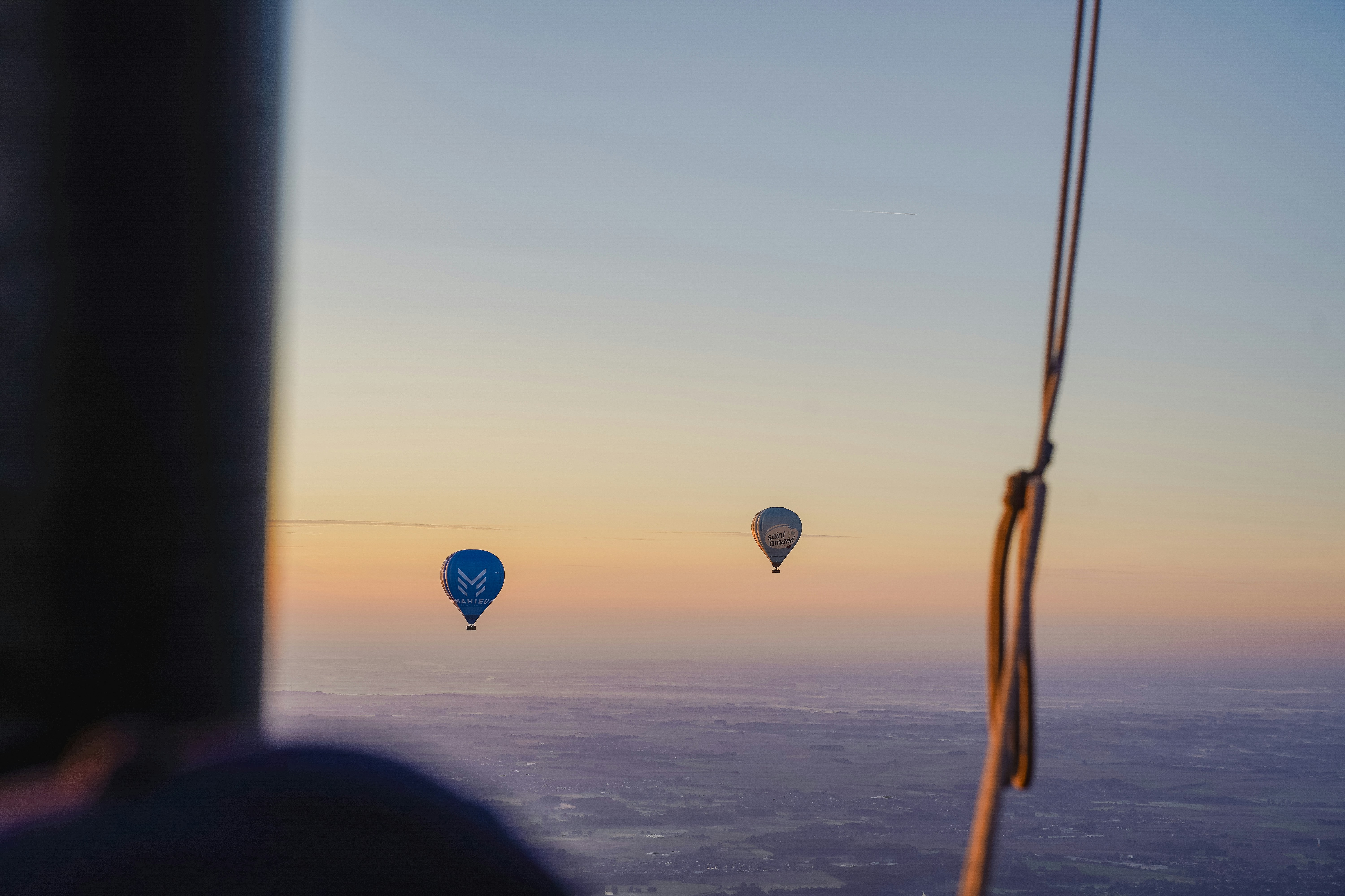 Dawn Ascent: Balloons Drifting Over a Quiet Horizon