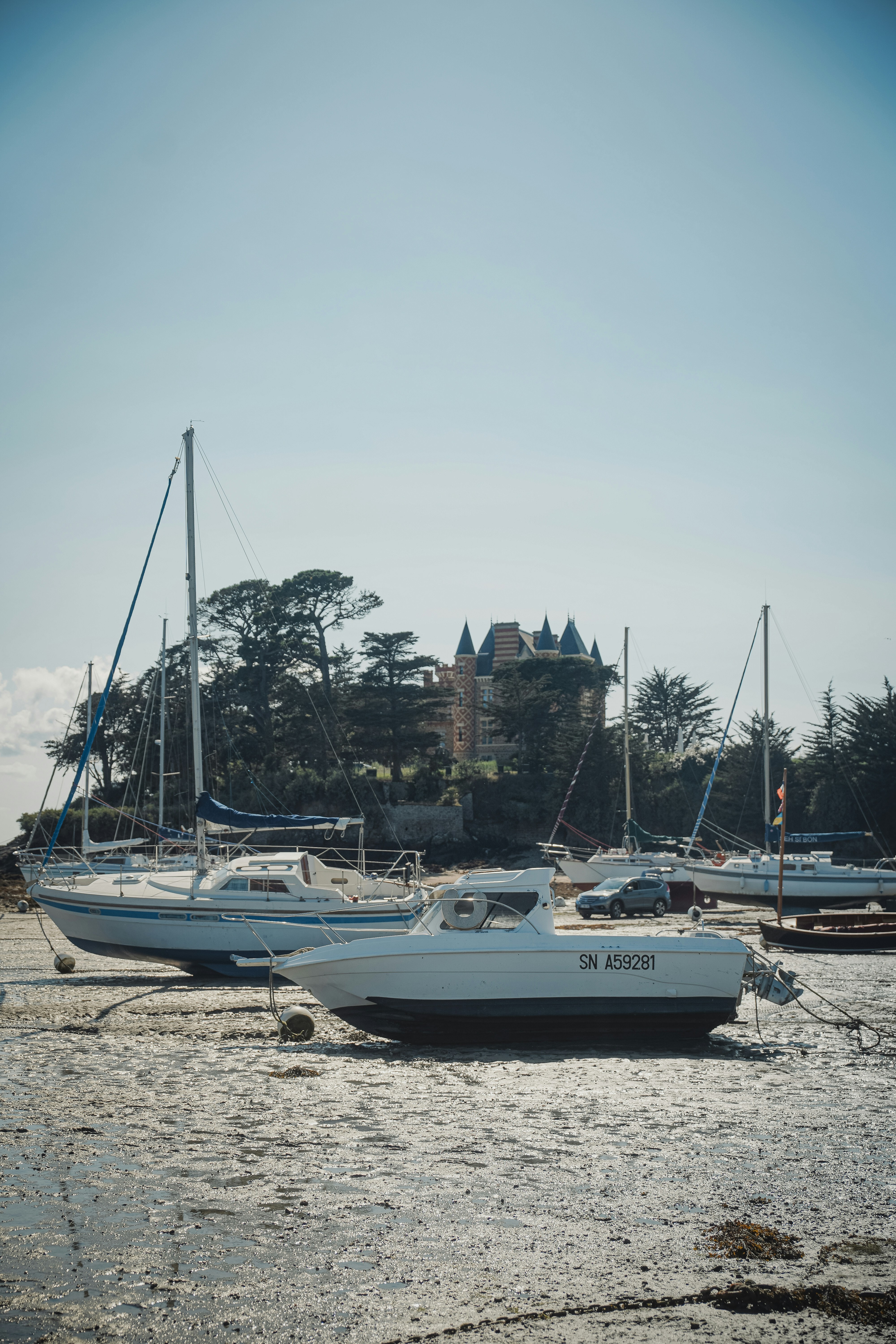 Boats Rest at Low Tide Beneath a Seaside Keep