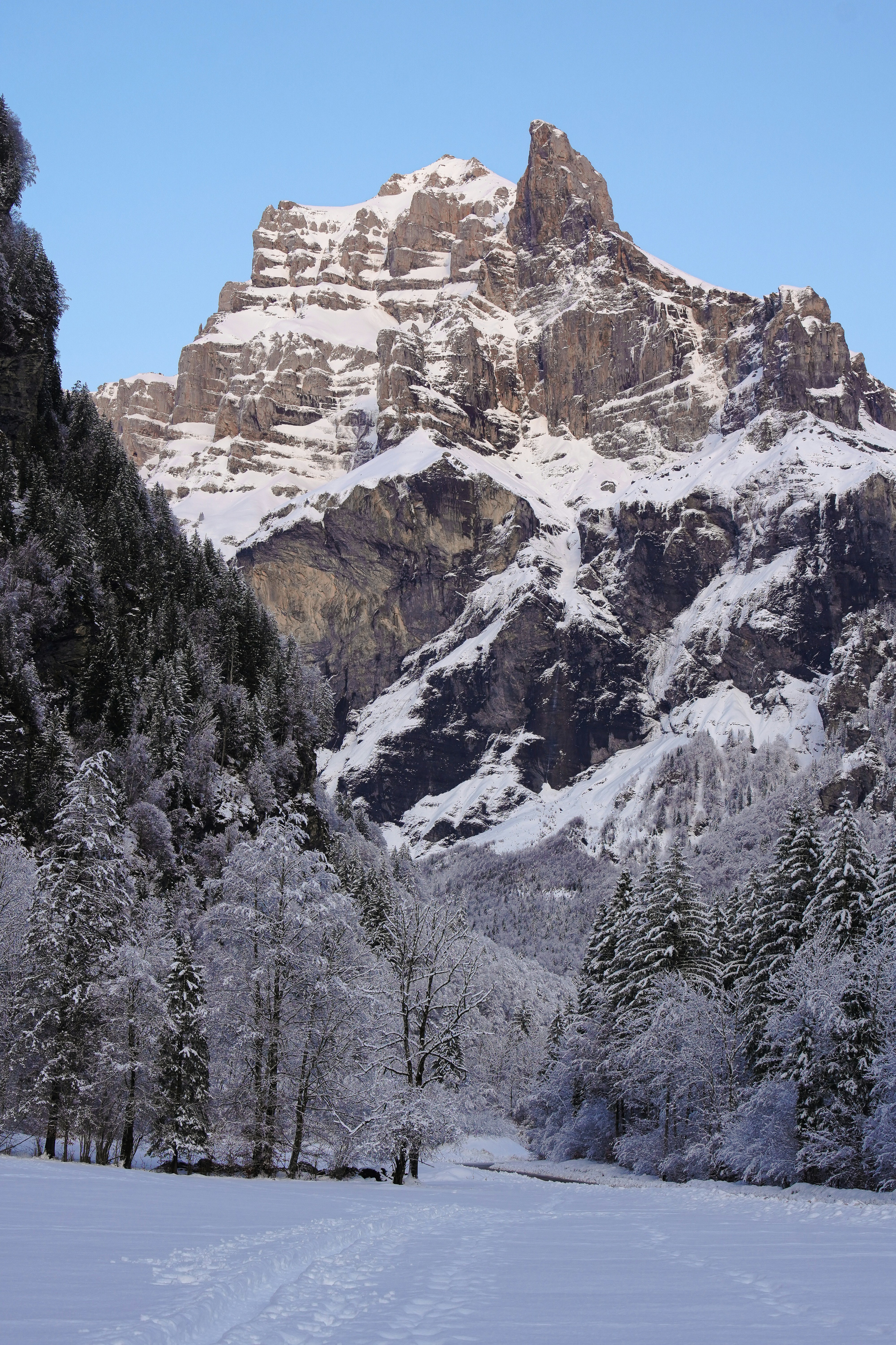 Snowbound Sentinel: A Jagged Peak Crowned in Frost