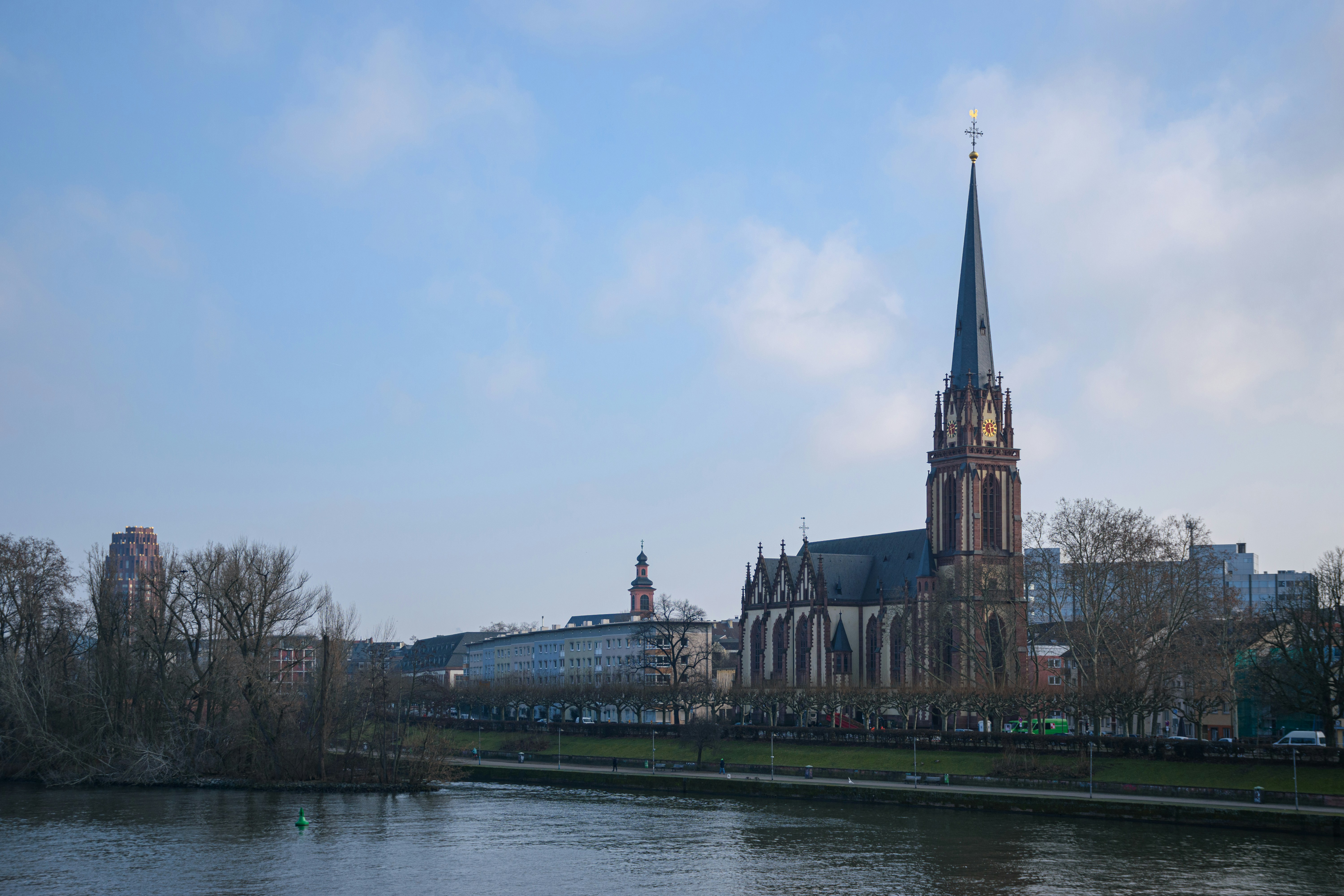 Cathedral Spire Rising Over the Riverbank