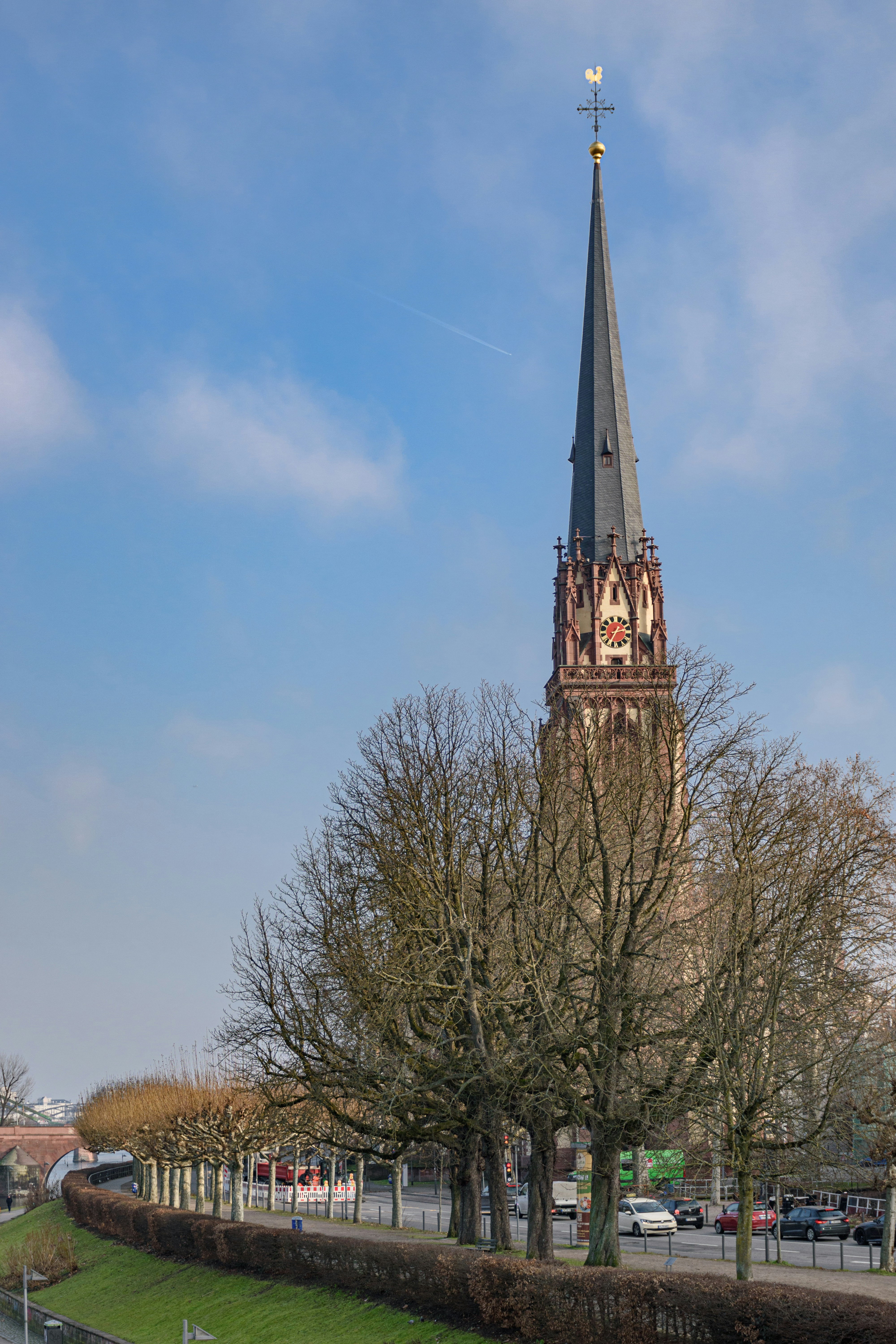 Spire Against the Sky: A Church Steeple Rising Over Winter Trees