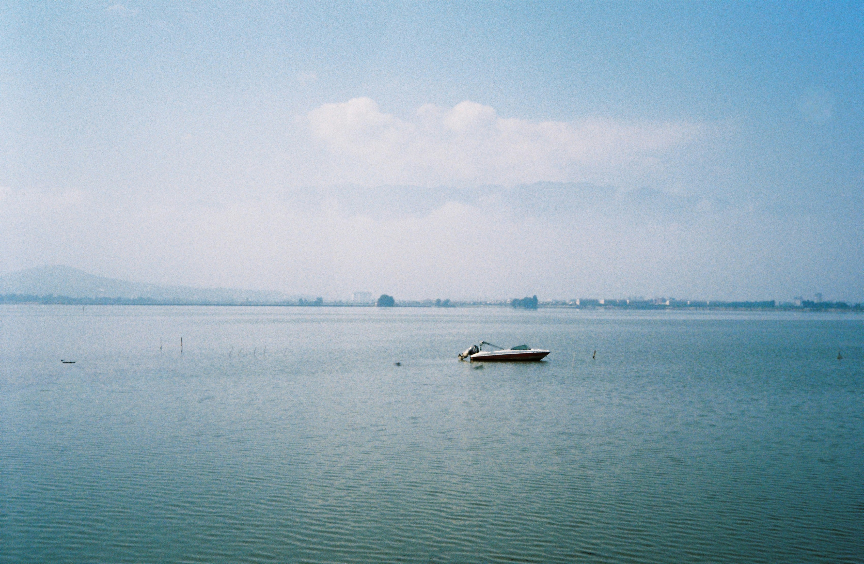 Quiet Boat on a Misty Lake: A Wide Horizon
