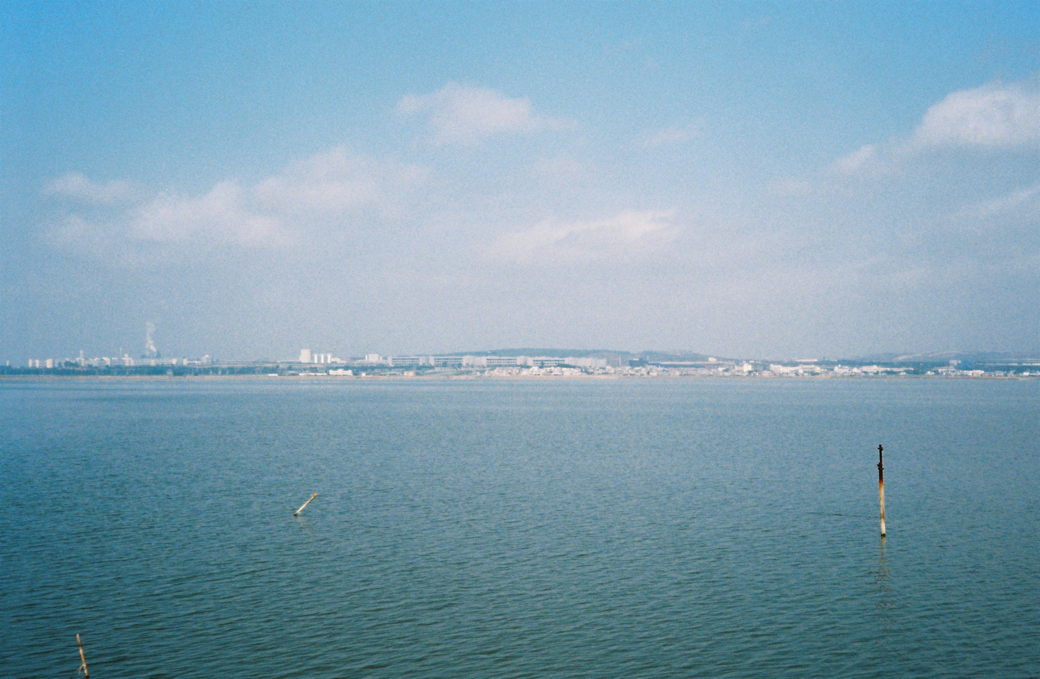 Horizon of Quiet Water: Distant City Silhouette Across a Calm Sea