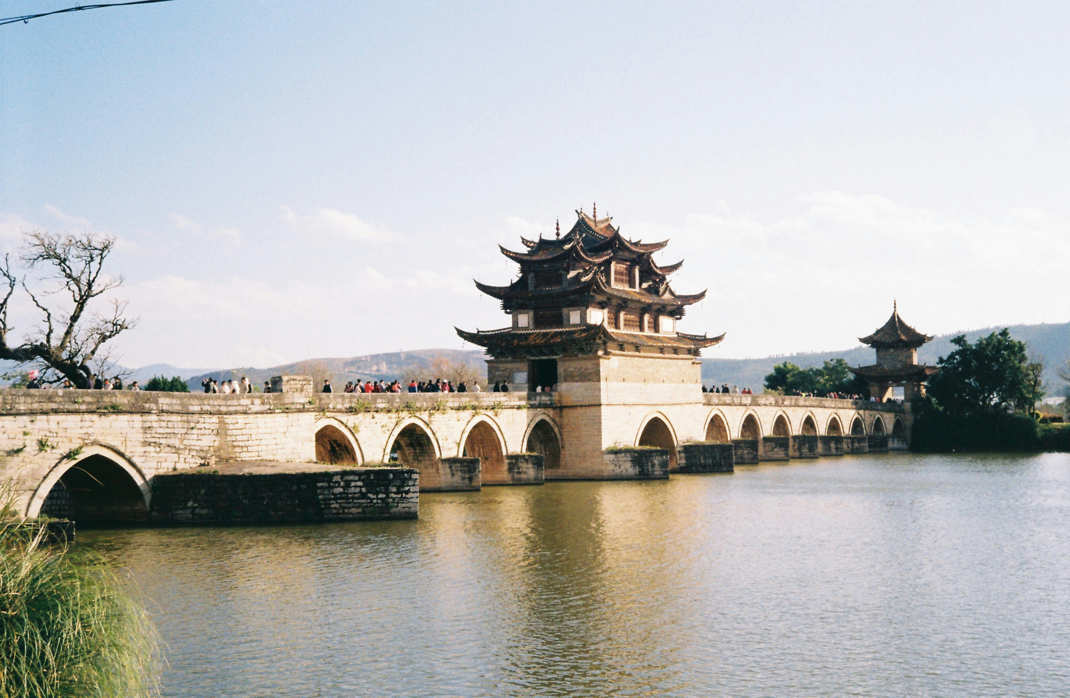 Bridge of Winds and Water: Ancient Chinese Archway Spanning a Gentle Lake