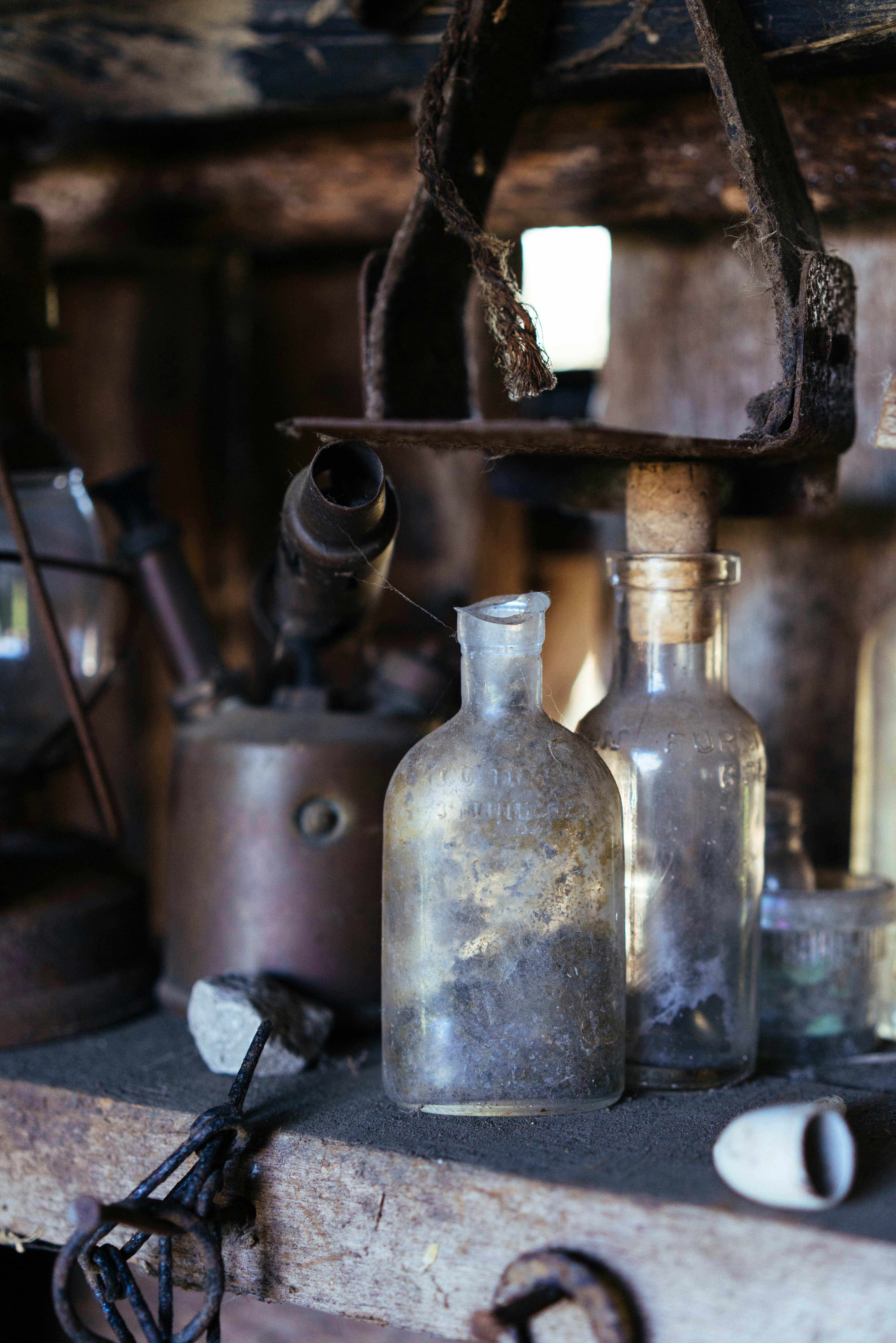 Dusty Bottles on a Rusty Workbench