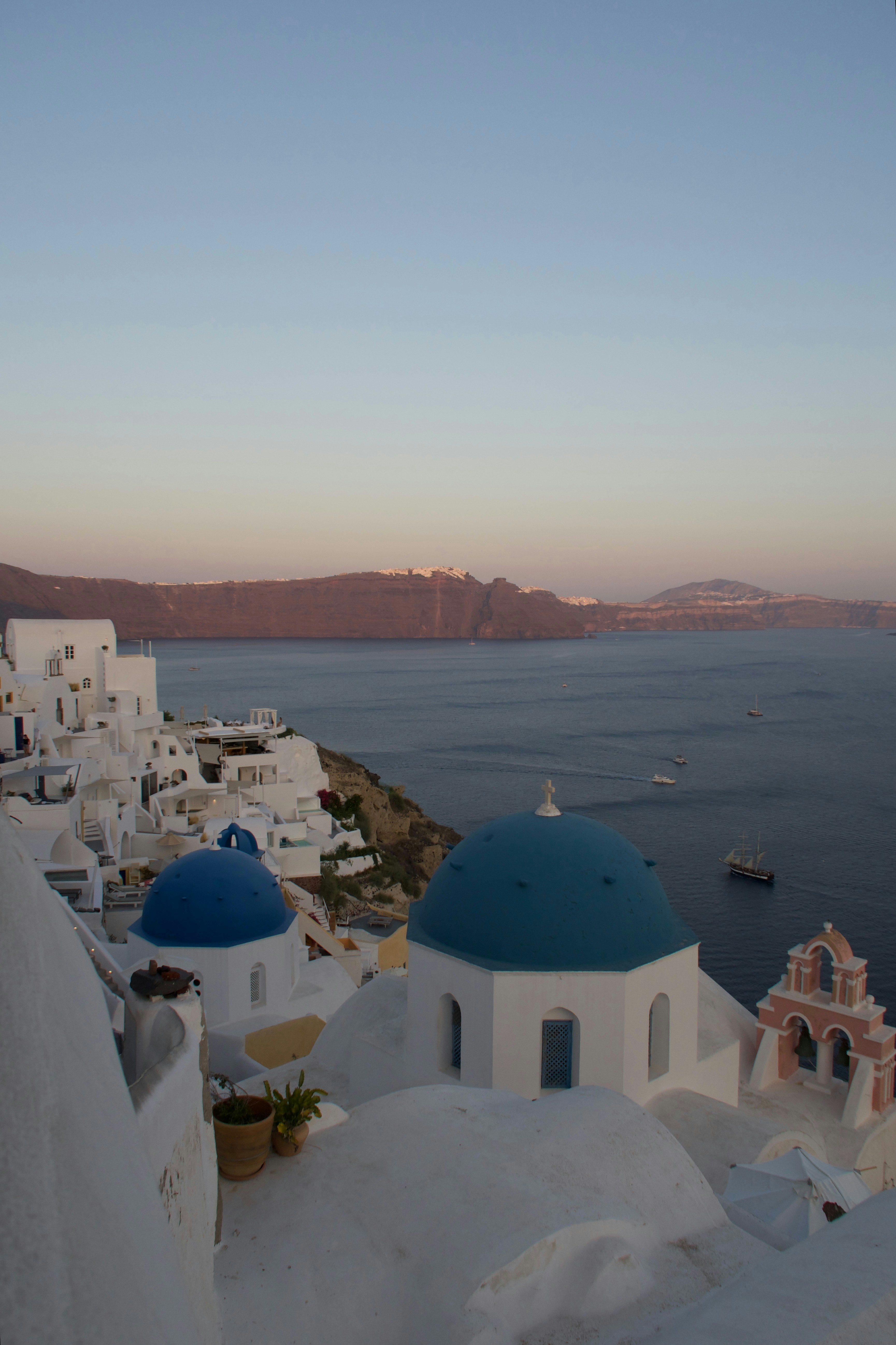 Blue Domes Over Aegean: Whitewashed Steps toward the Sunset