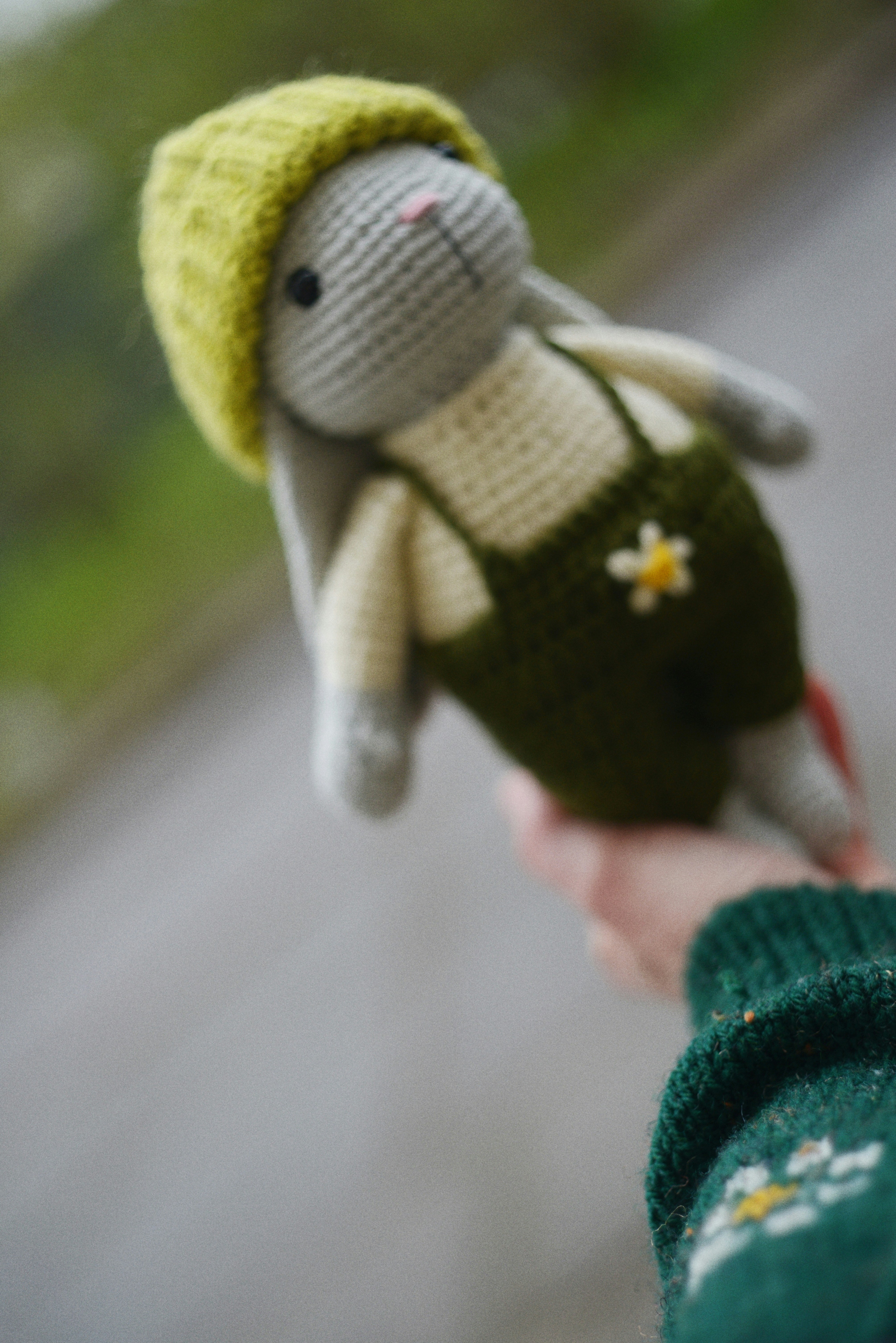 Handheld Knitted Doll Reaches for the Viewer