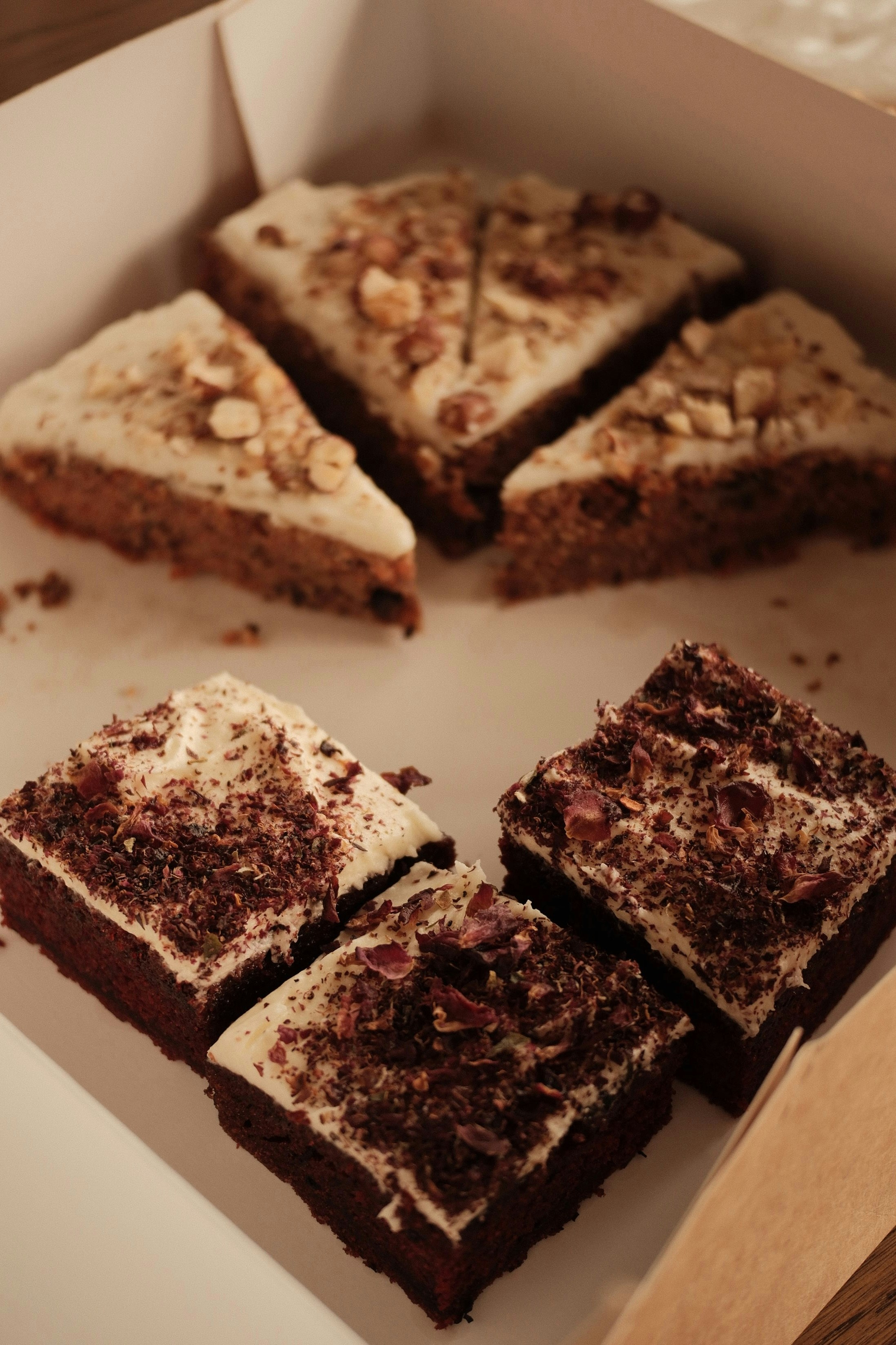 Slices of Chocolate Walnut Cheesecake: A Close-Up in a Cardboard Box