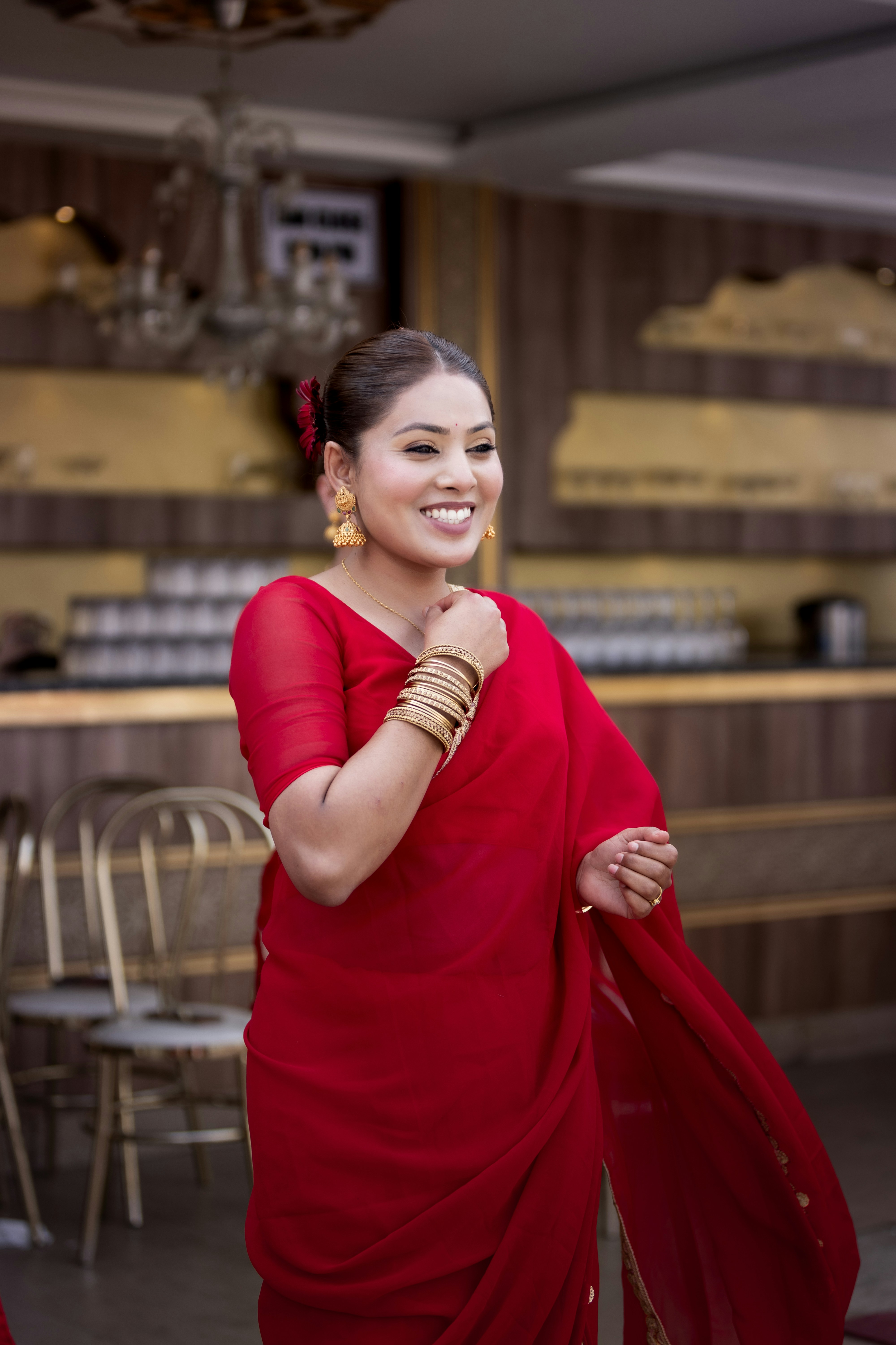 Red‑Sari Radiance: A Confident Smile at the Baroque Backdrop