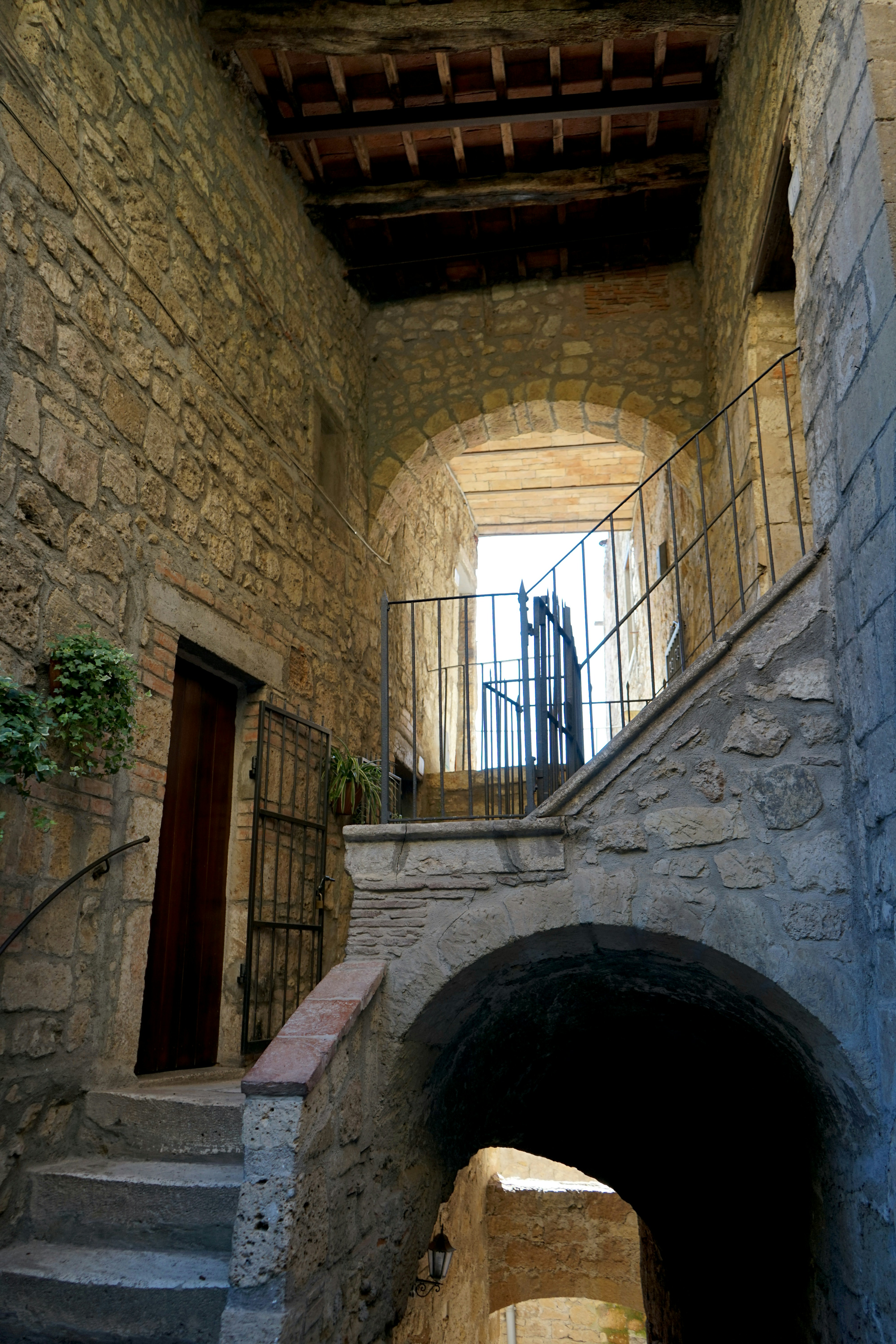 Stone Staircase to Light: An Archway Corridor in an Aged Fortress