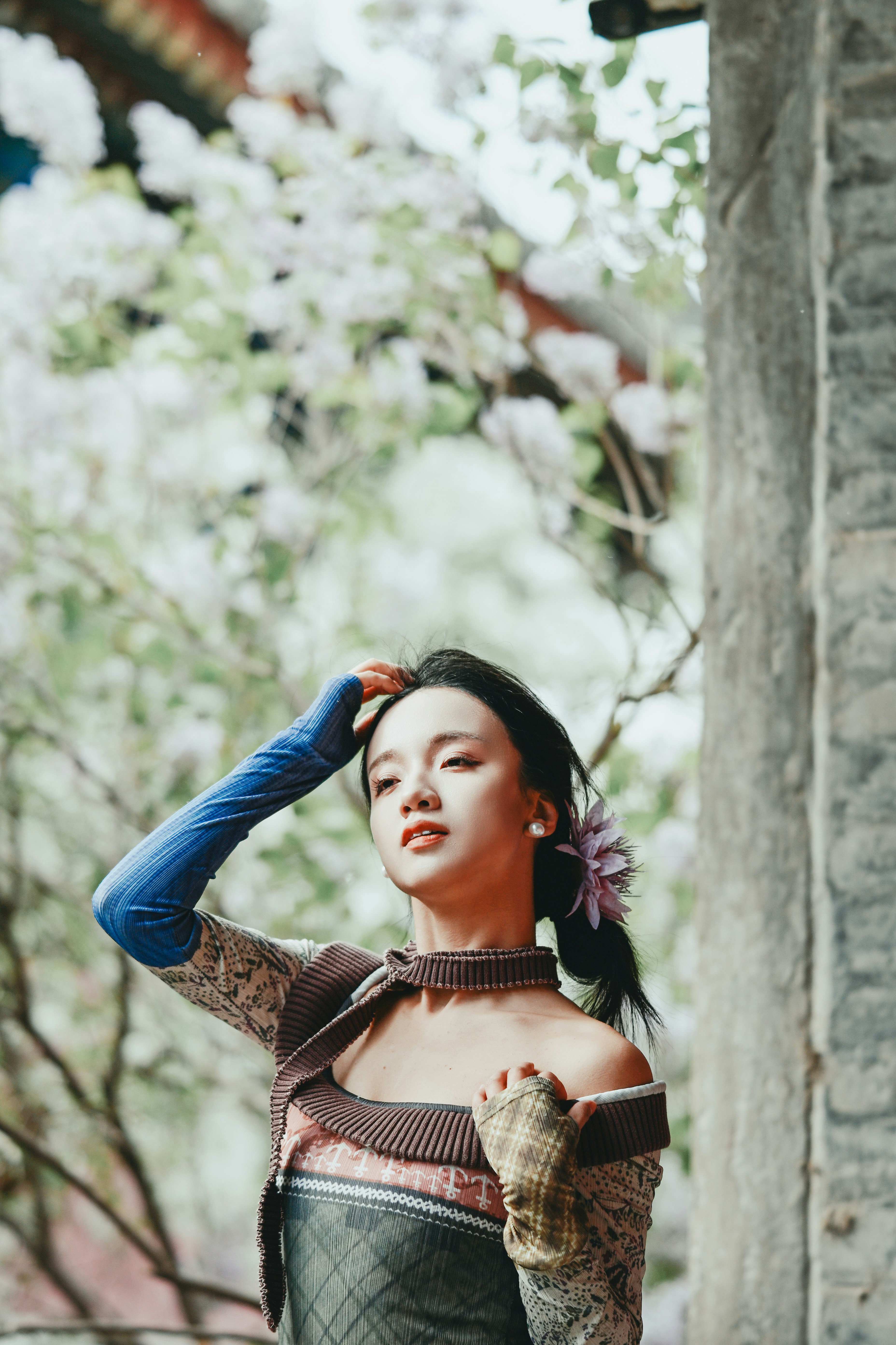 Grace in Bloom: Portrait of a Woman Amid Blossoming Archways