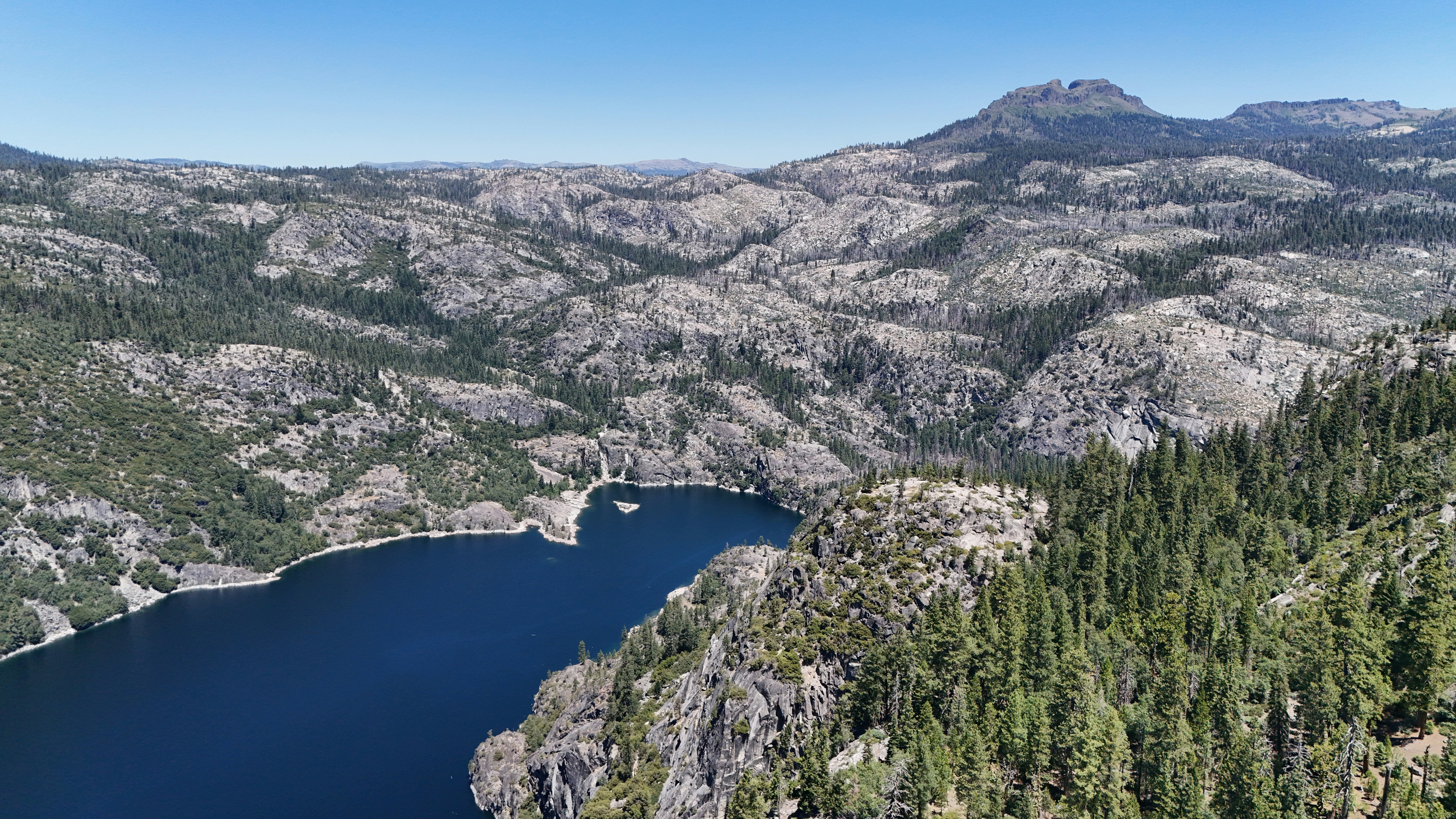 Aegean-like canyon lake cradle of granite and pines