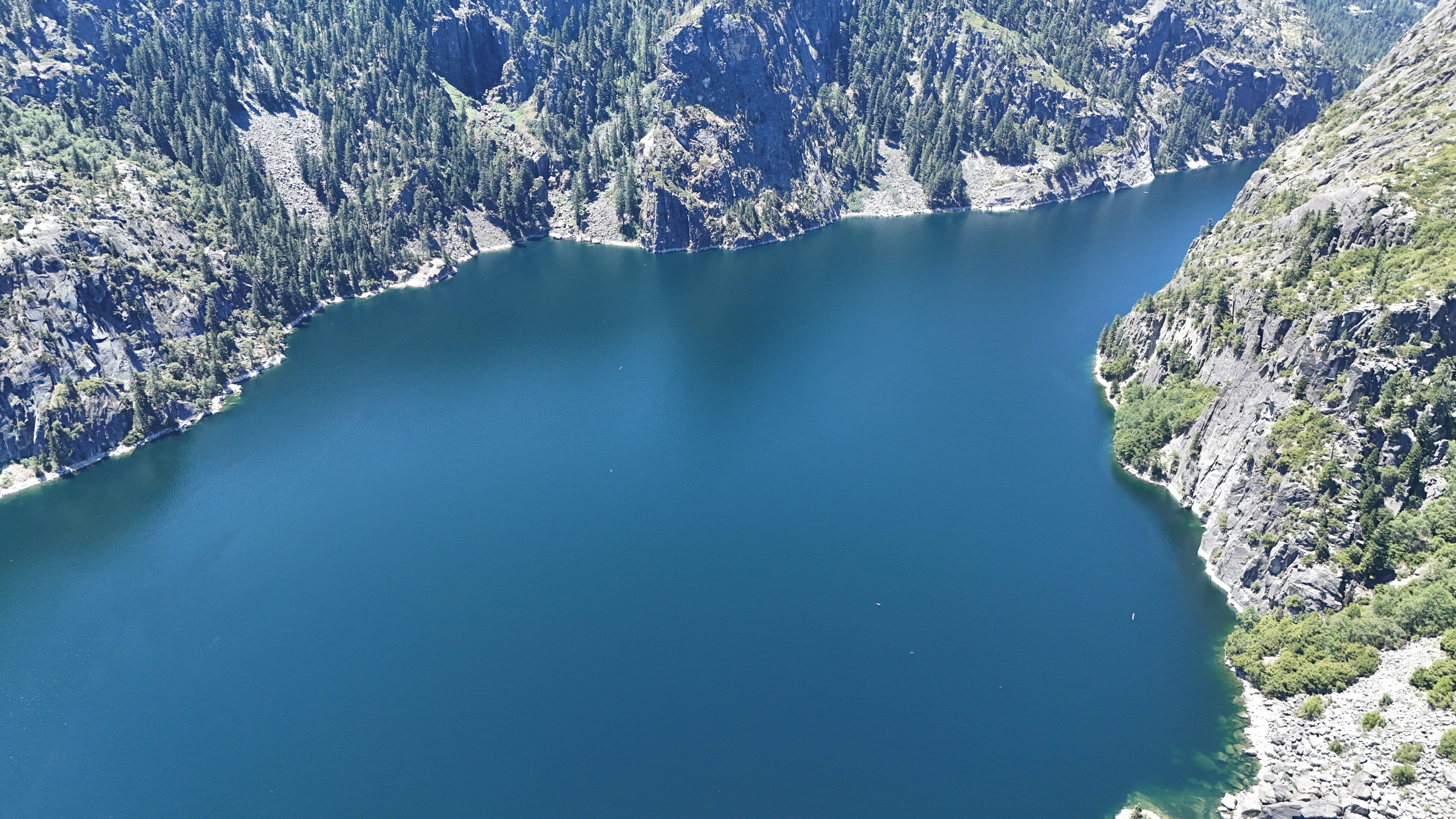 Mid-Summer Fjord: A Serene Blue Reservoir Hidden Among Alpine Cliffs