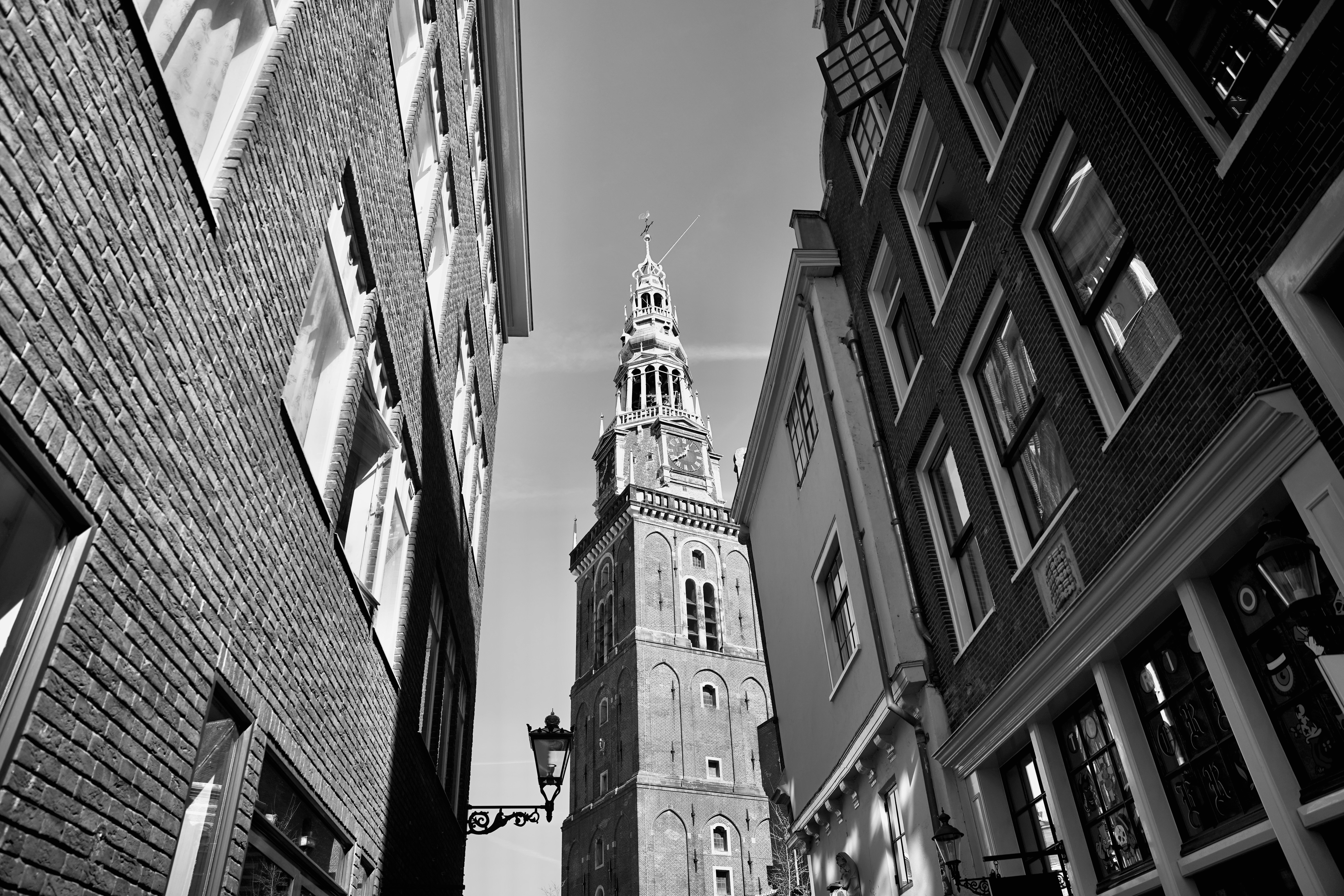 Towering City Narrow: A Victorian Spire Between Cobblestone Canopies