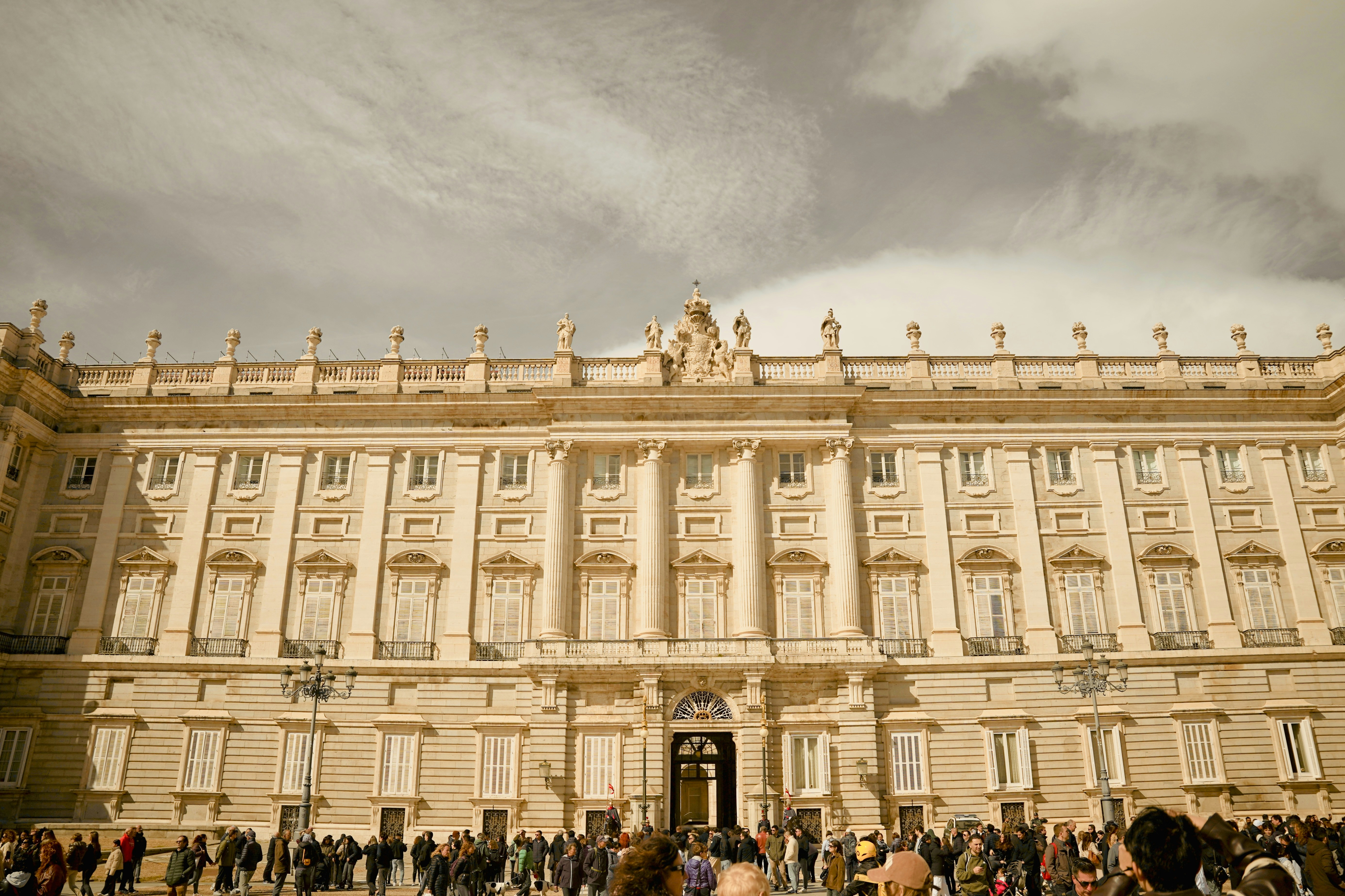 Grand Facade of the Palace: A Crowd Beneath Baroque Detailing