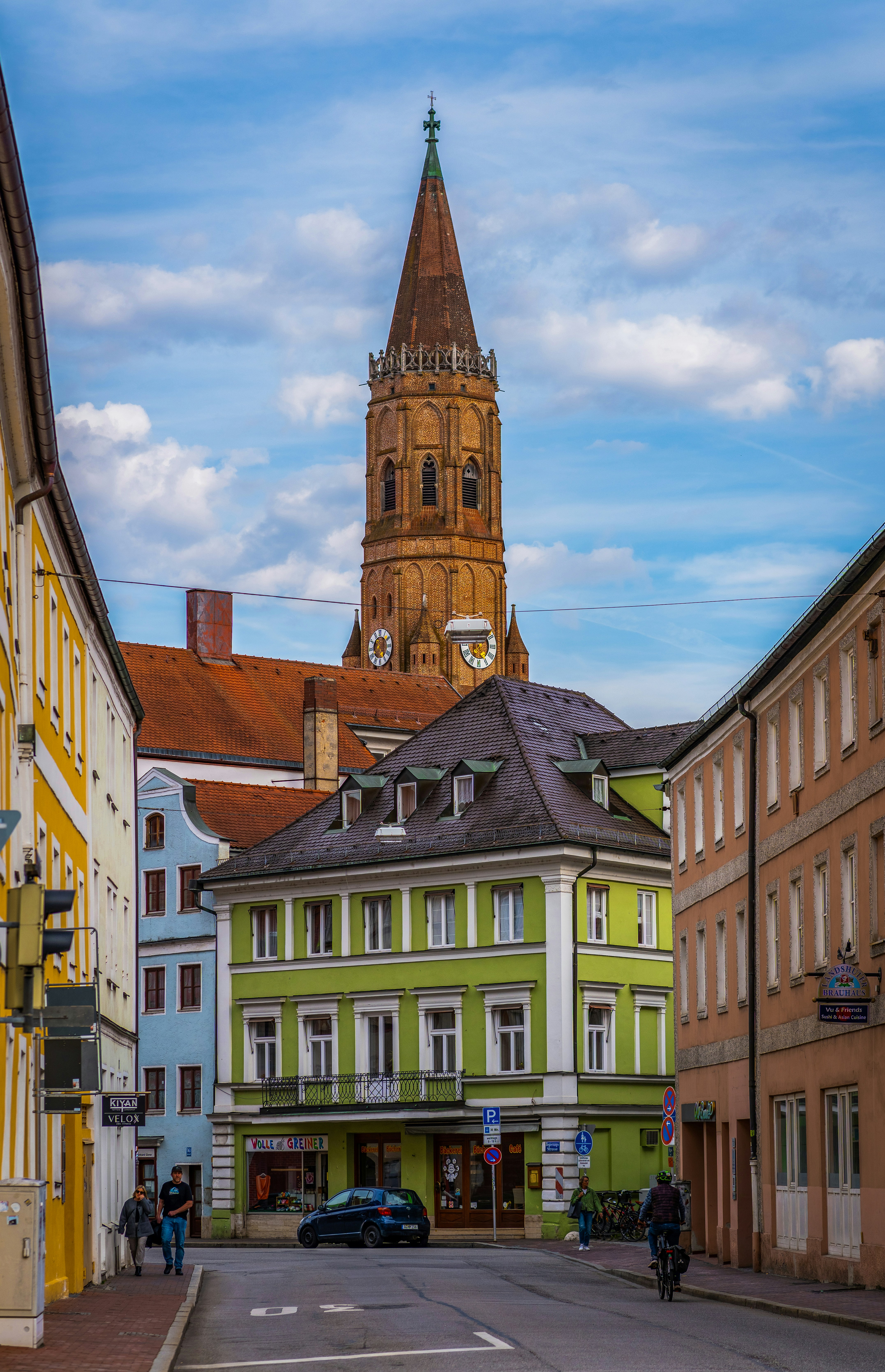 Clocktower Amid Colorful Facades: A Quiet Street Scene