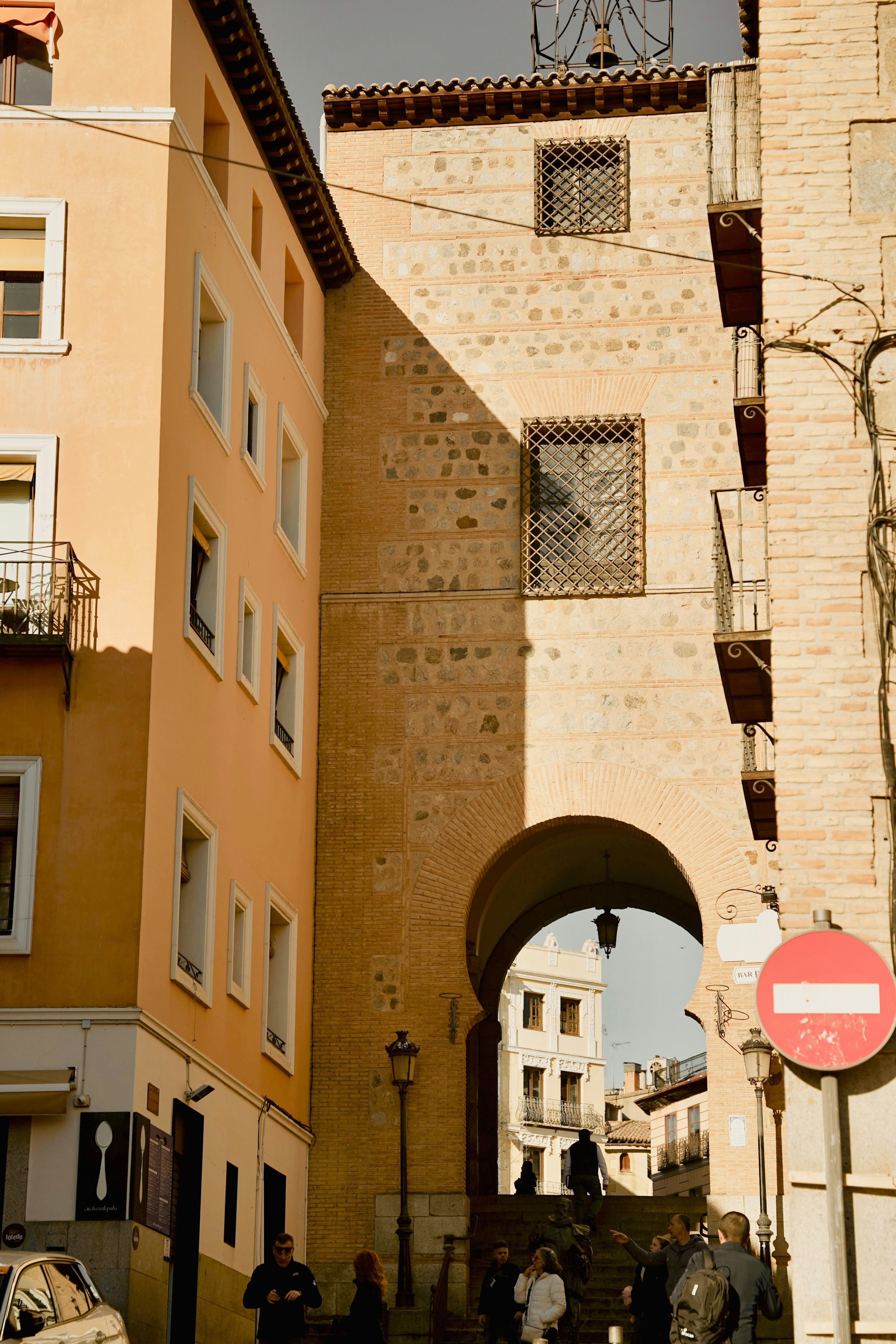 Through the Arch: A Sunlit Street Between Historic Walls
