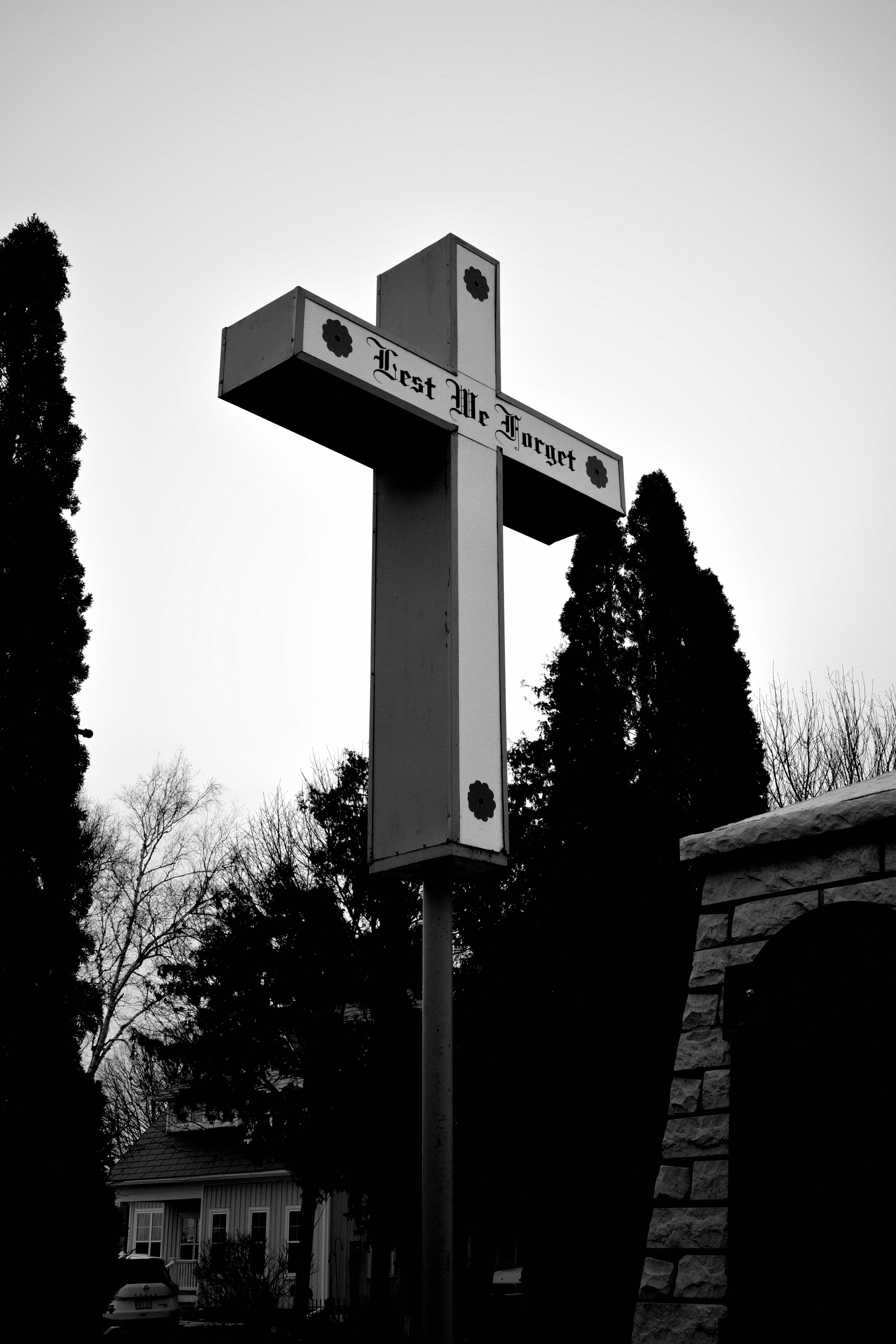 Cross of remembrance rising over a quiet graveyard