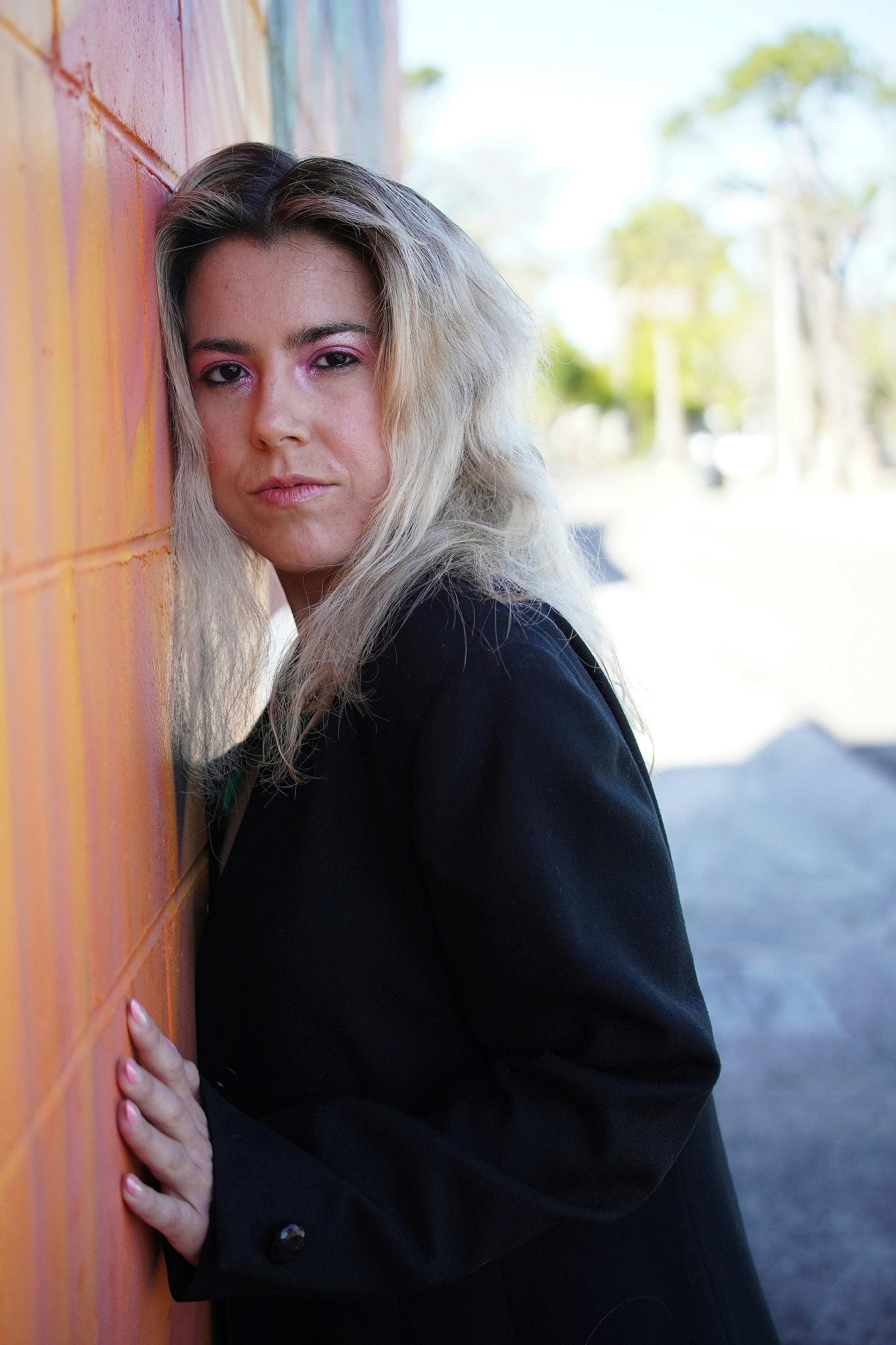 Portrait at the Wall: Quiet Confidence by the Orange Brick