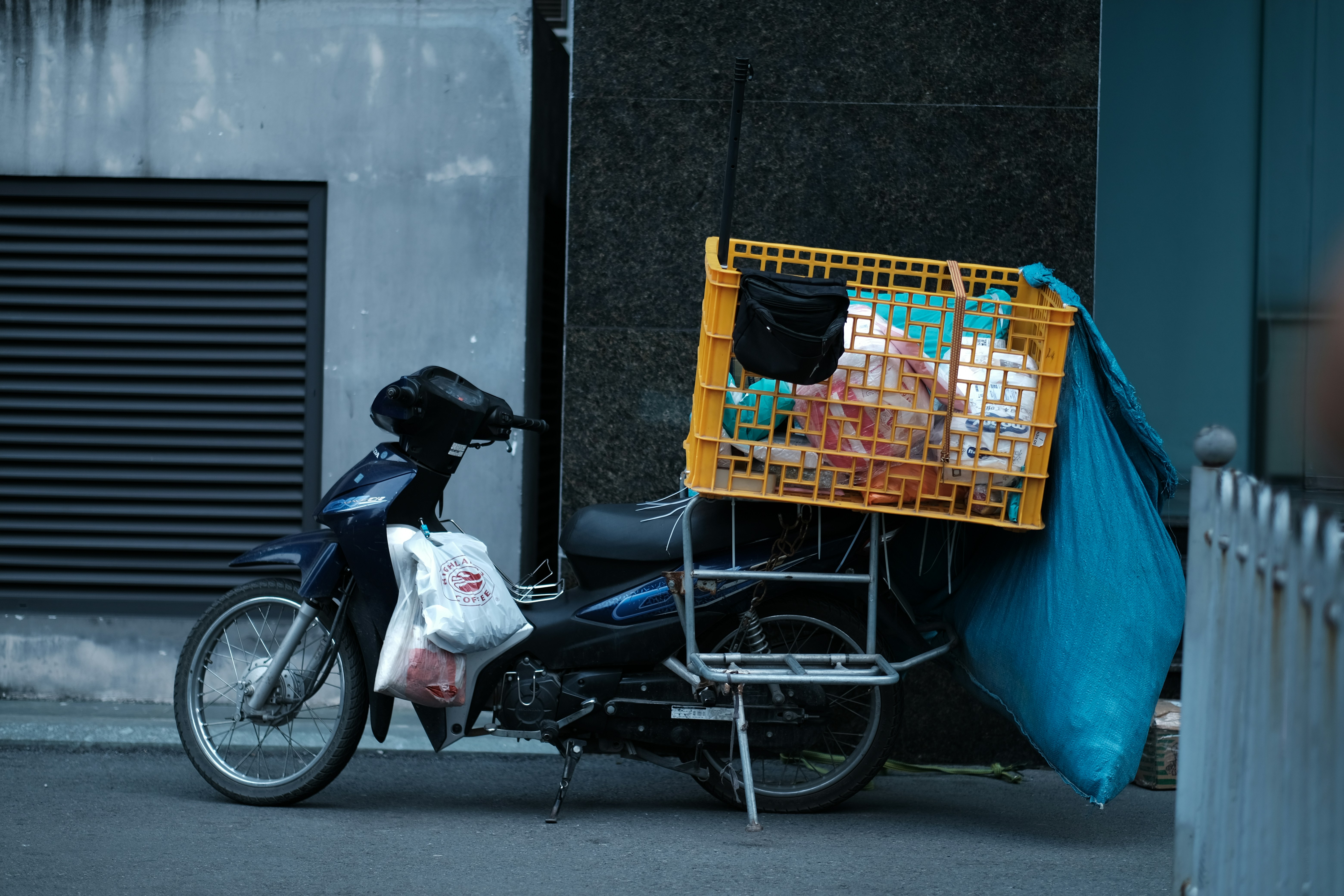 Frontier Delivery: A motorcycle laden with a bustling market in a narrow urban alley
