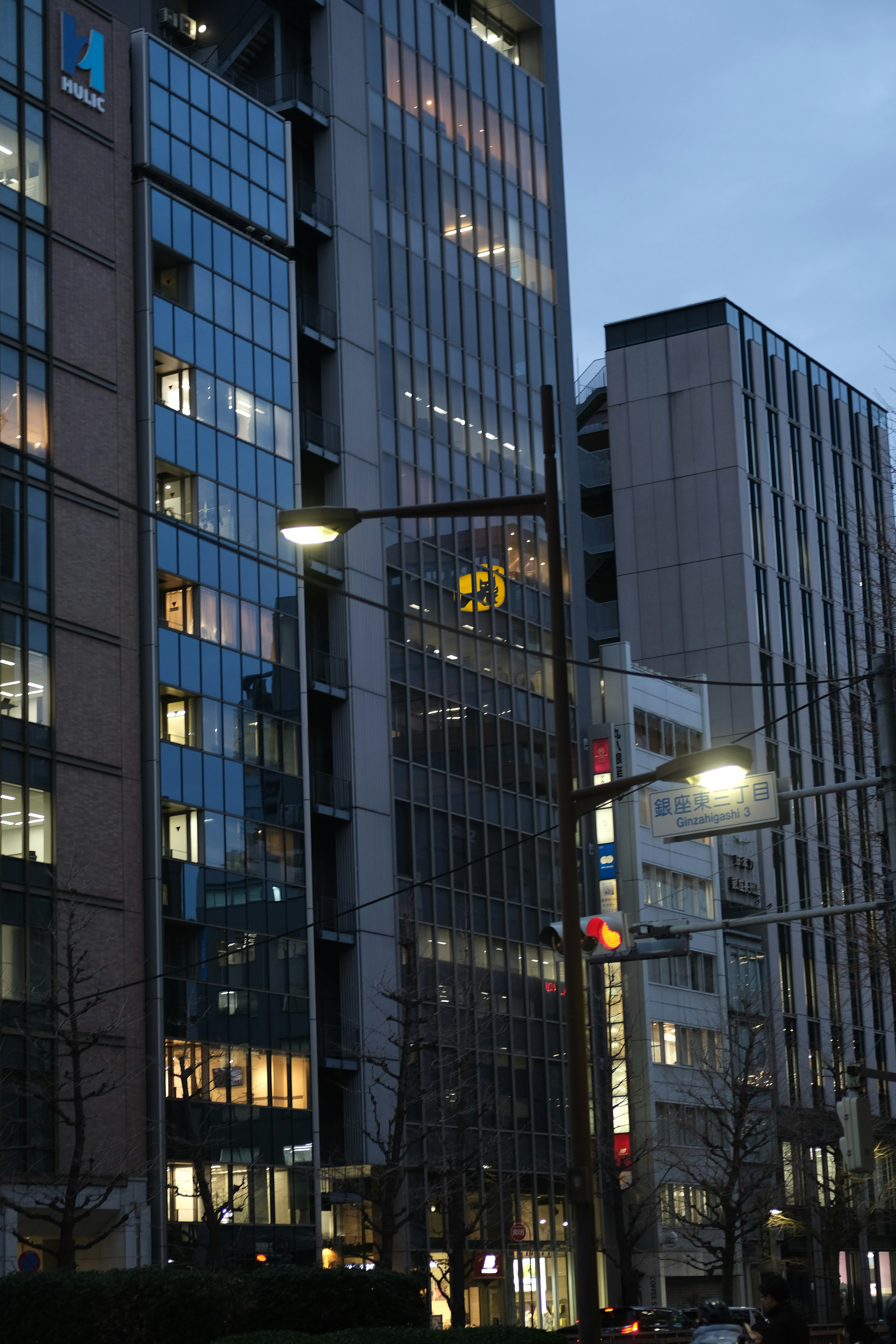 Urban Glass: Nighttime Facade Rising Above the Street