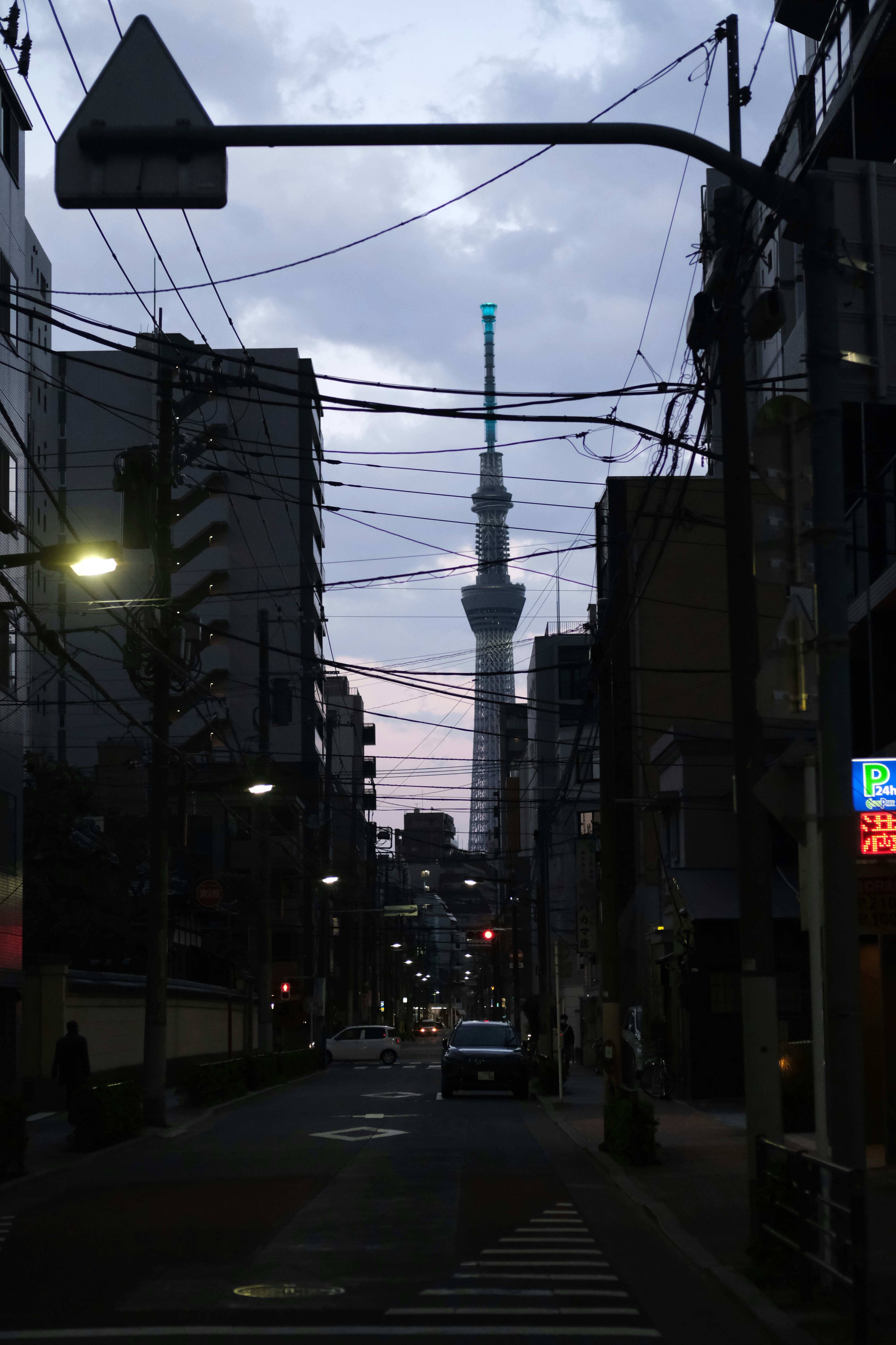 Tokyo Skyline Streak: Tokyo Tower Peeking Over a Dim Street